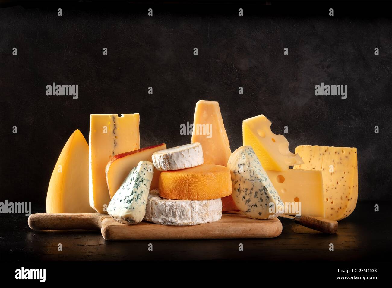 Organic cheeses on a black background with a place for text Stock Photo ...