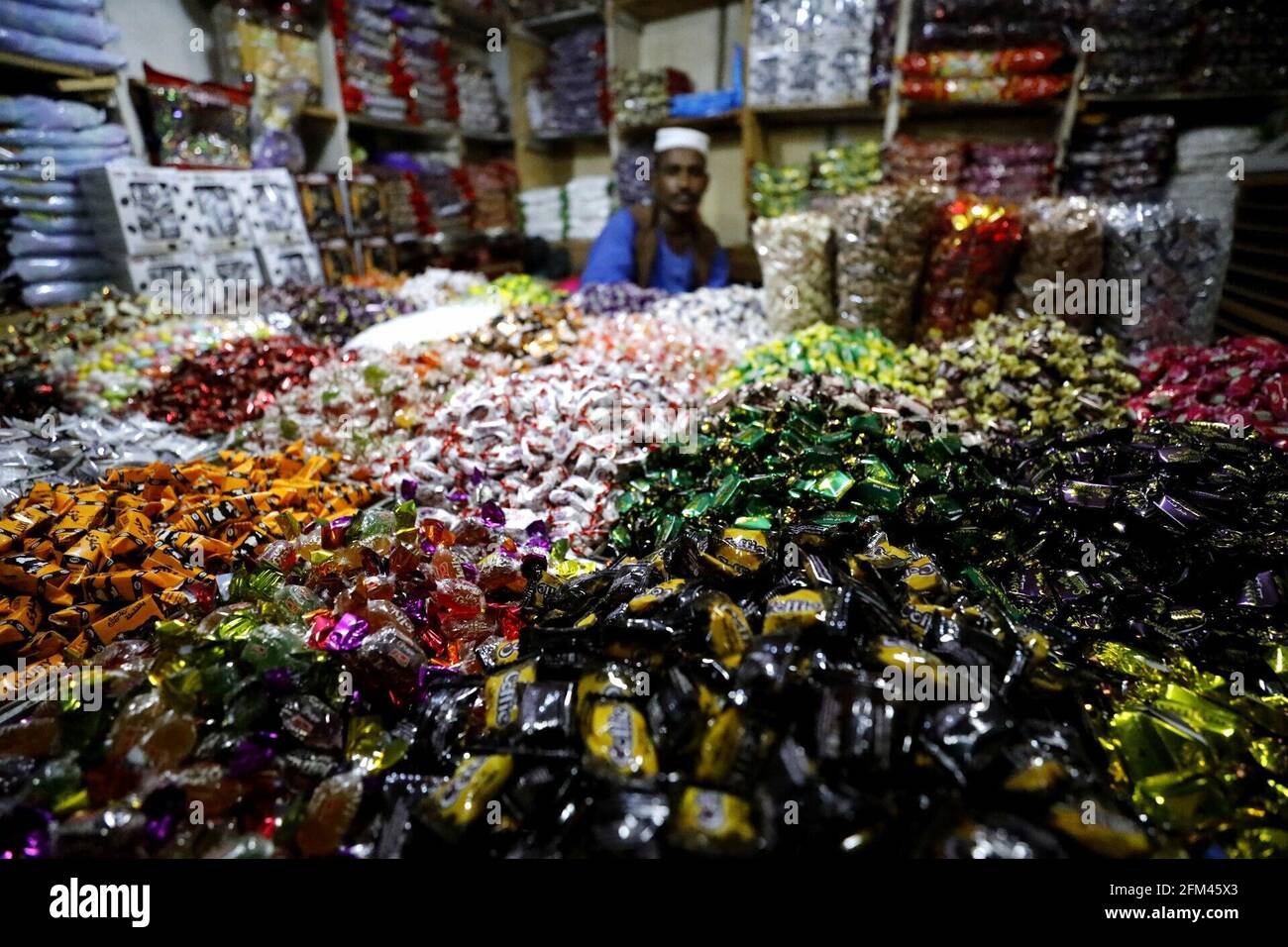 Khartoum, Sudan. 5th May, 2021. A vendor sells sweets at a market in ...