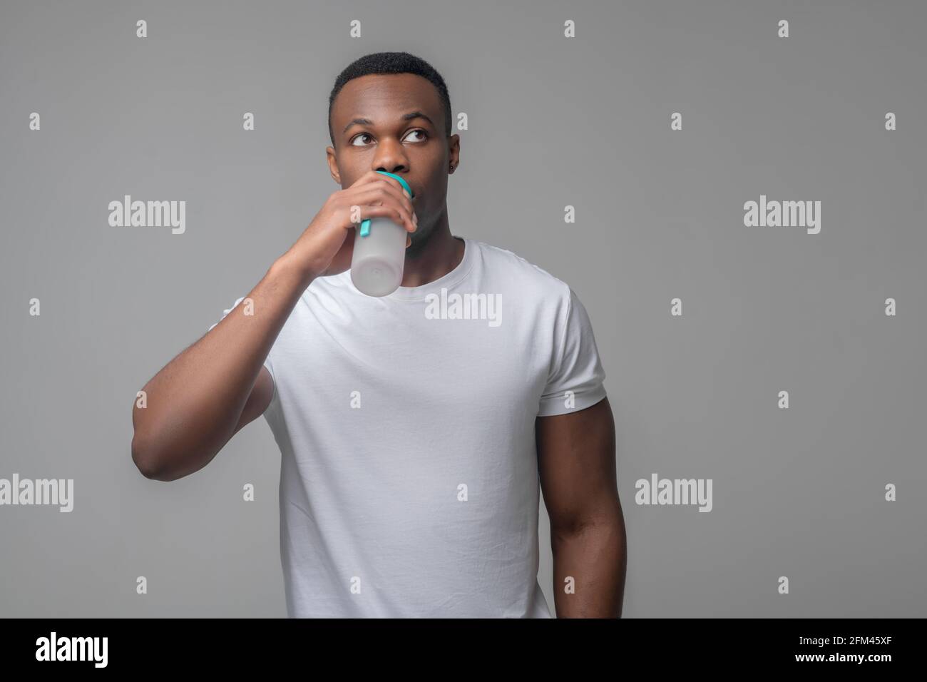 Handsome young sportsman standing drinking hi-res stock photography and ...