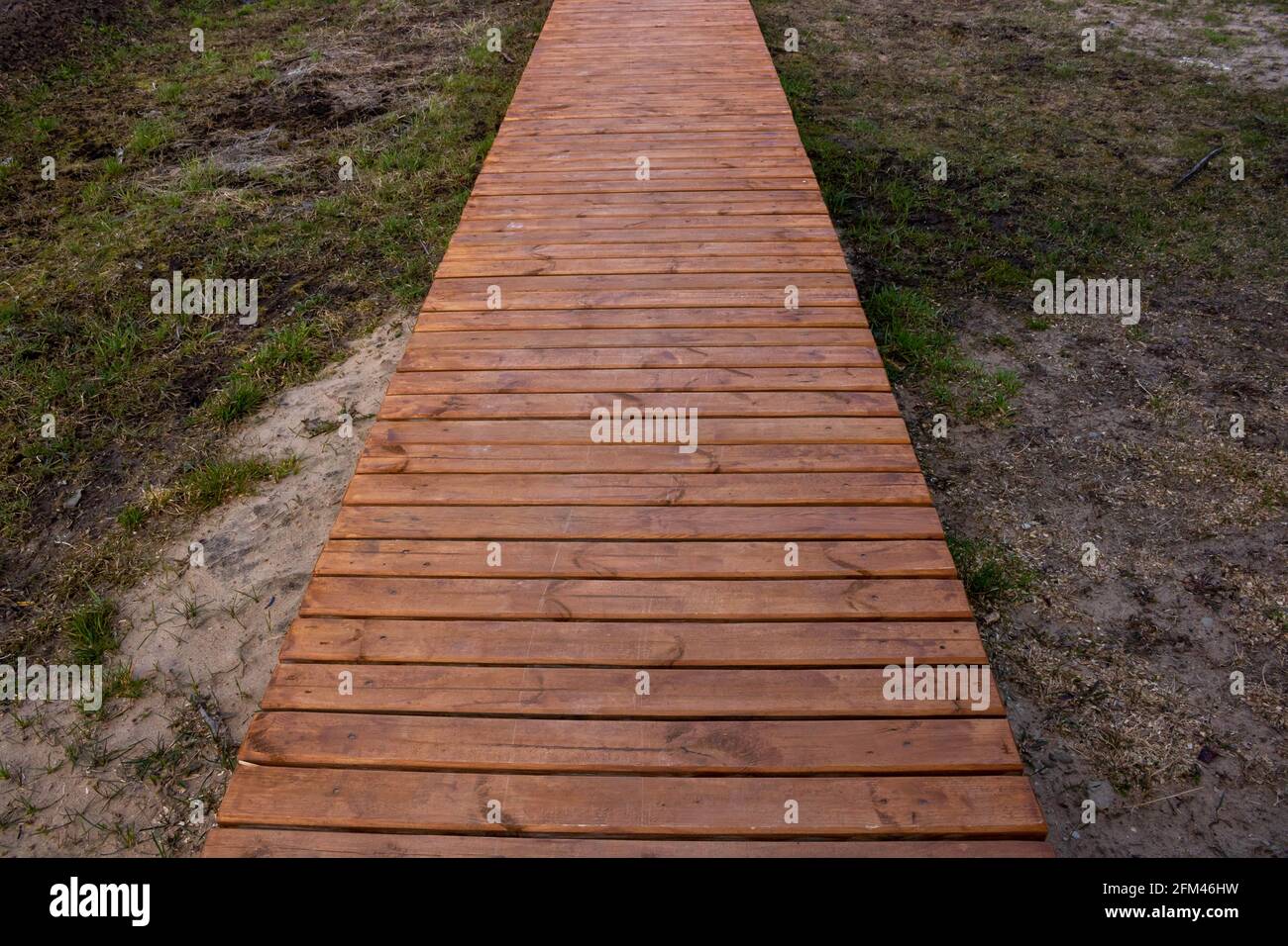 Wooden boardwalk walking path in the yard Stock Photo - Alamy