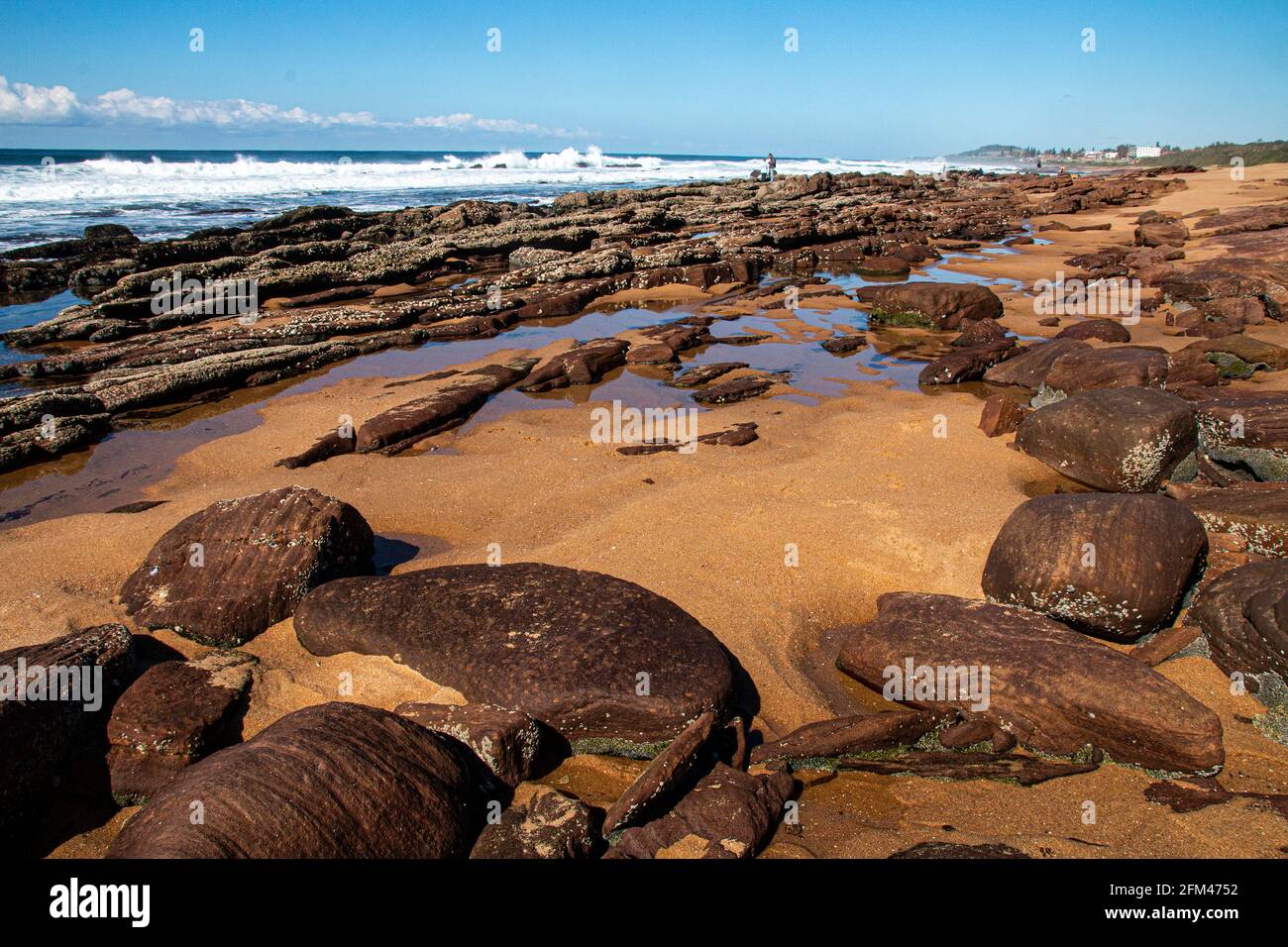 Layers of rocks on beach at low tide Stock Photo - Alamy