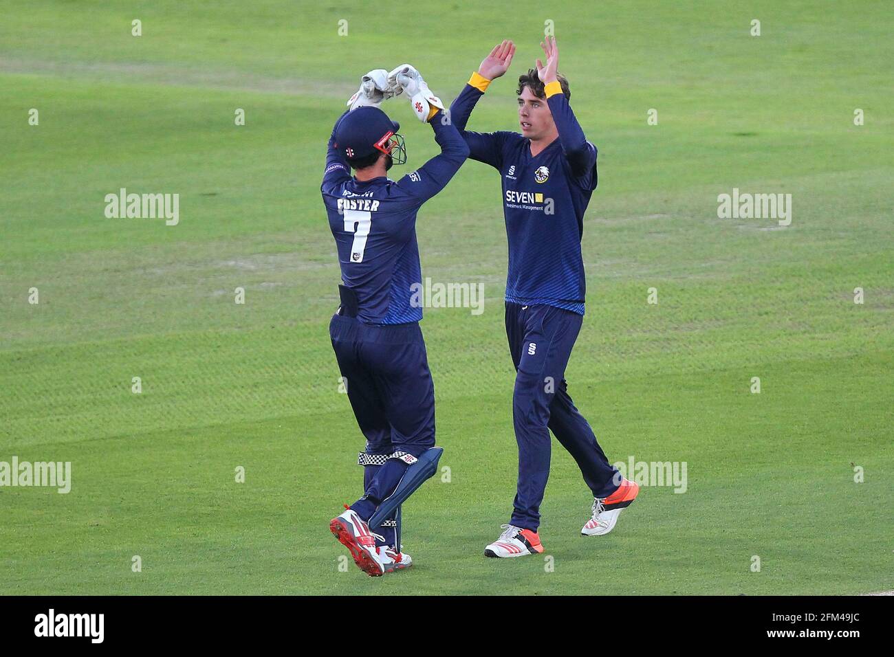 Daniel Lawrence (R) of Essex celebrates taking the wicket of Tom Alsop ...