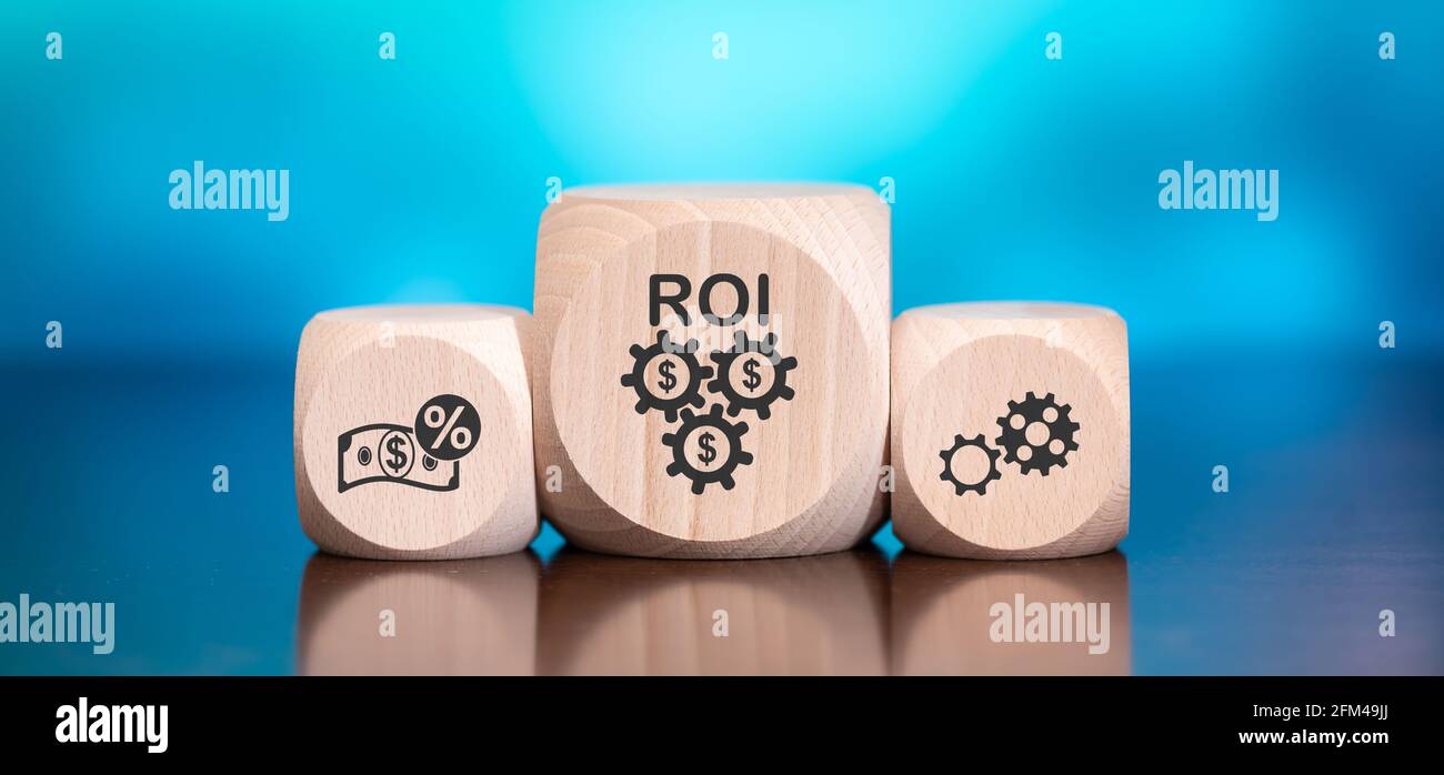 Wooden blocks with symbol of roi concept on blue background Stock Photo ...