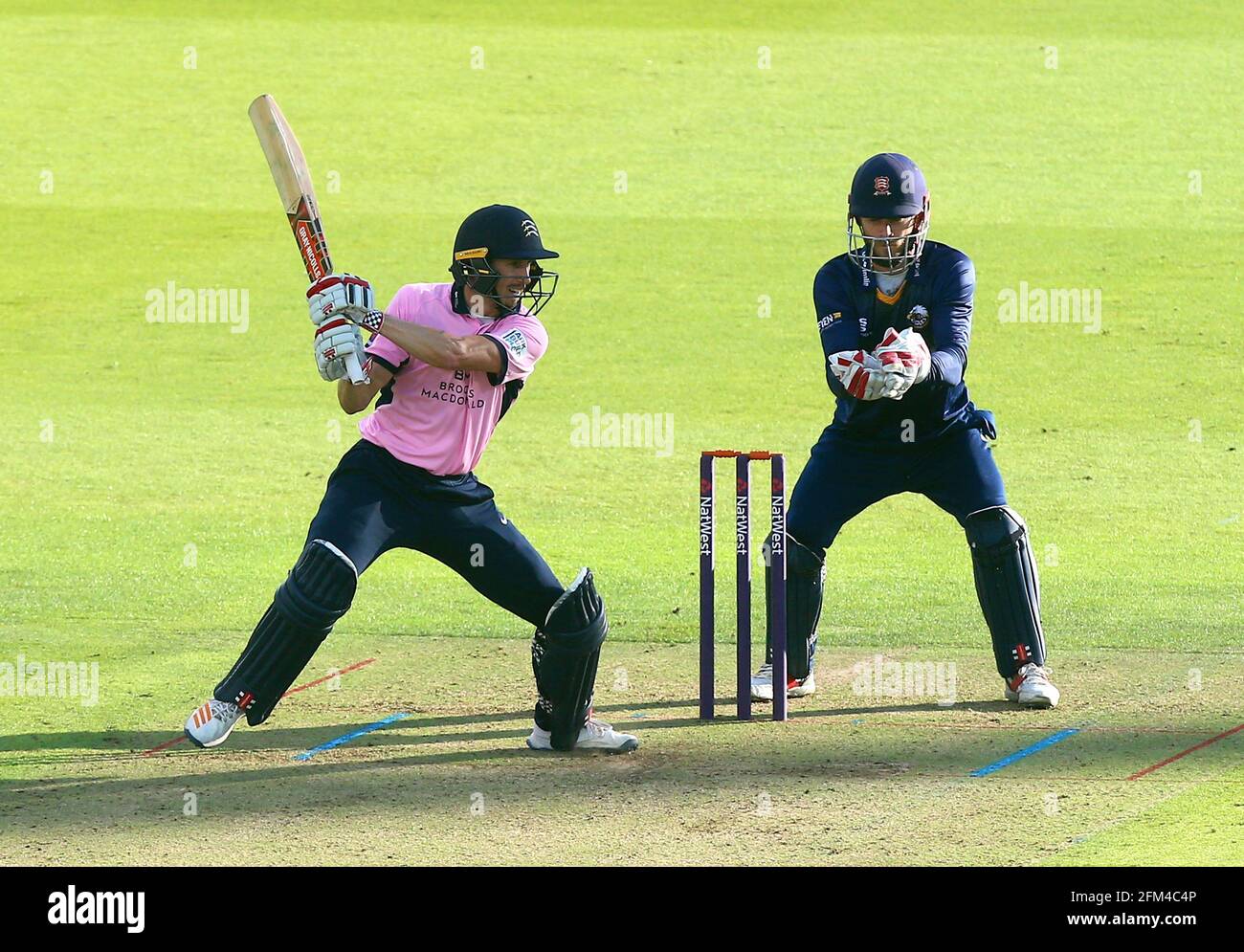 John Simpson hits out for Middlesex as James Foster looks on from ...