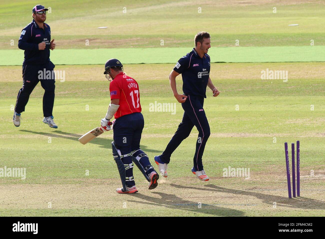 Toby Roland-Jones of Middlesex celebrates taking the wicket of Graham ...