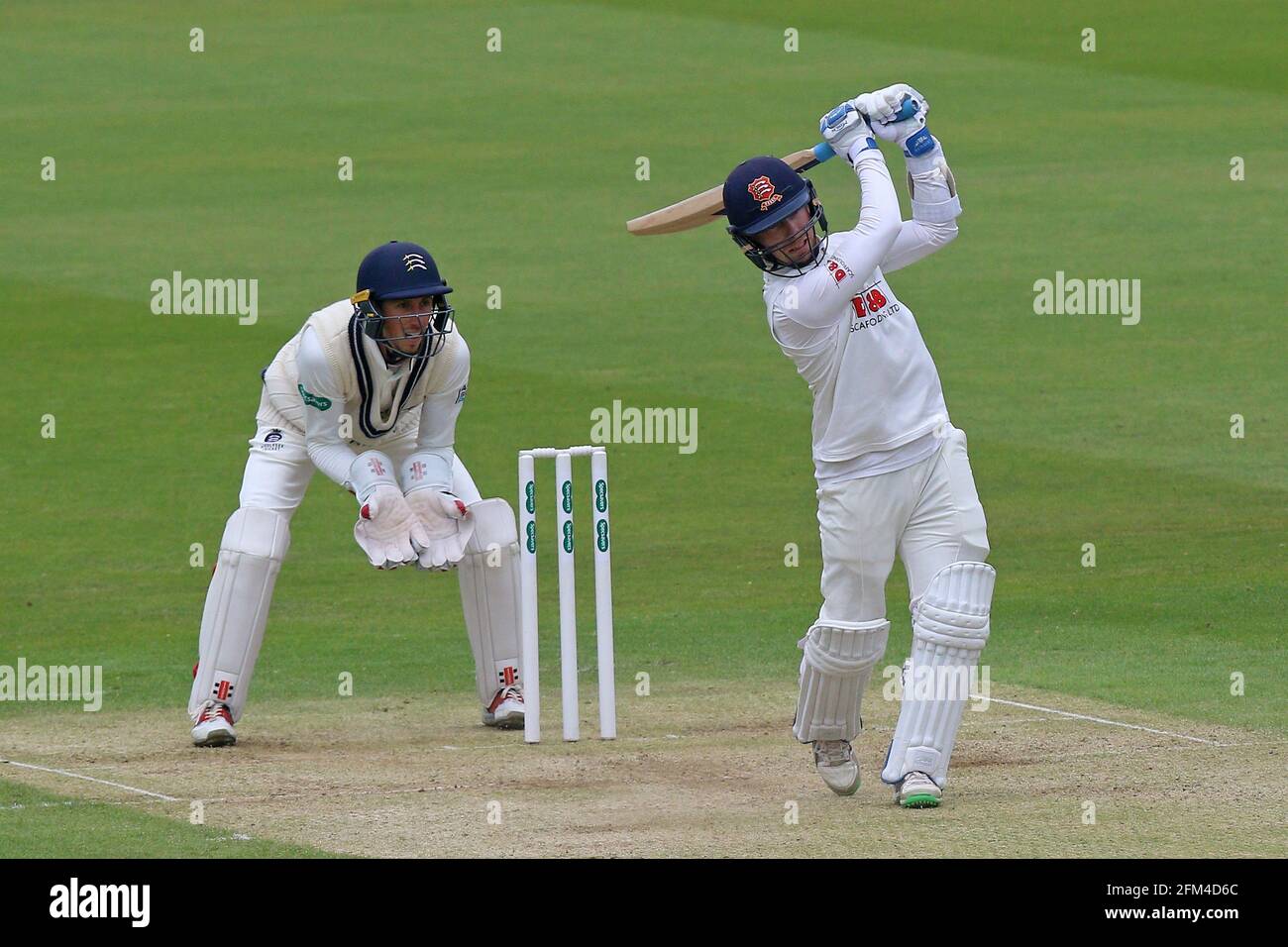 Adam Wheater hits four runs for Essex as John Simpson looks on from ...