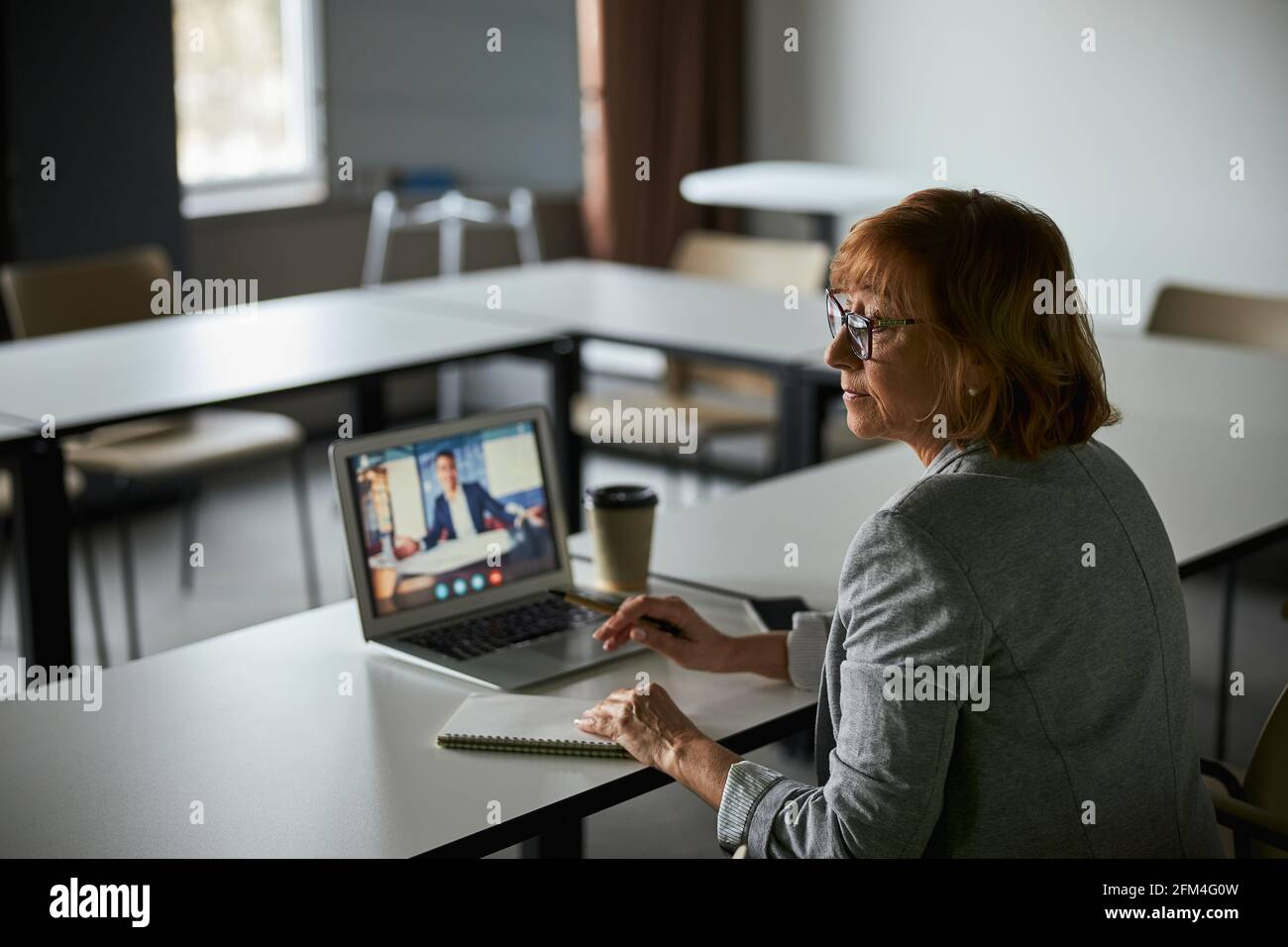 Female business manager getting distracted from online call Stock Photo ...