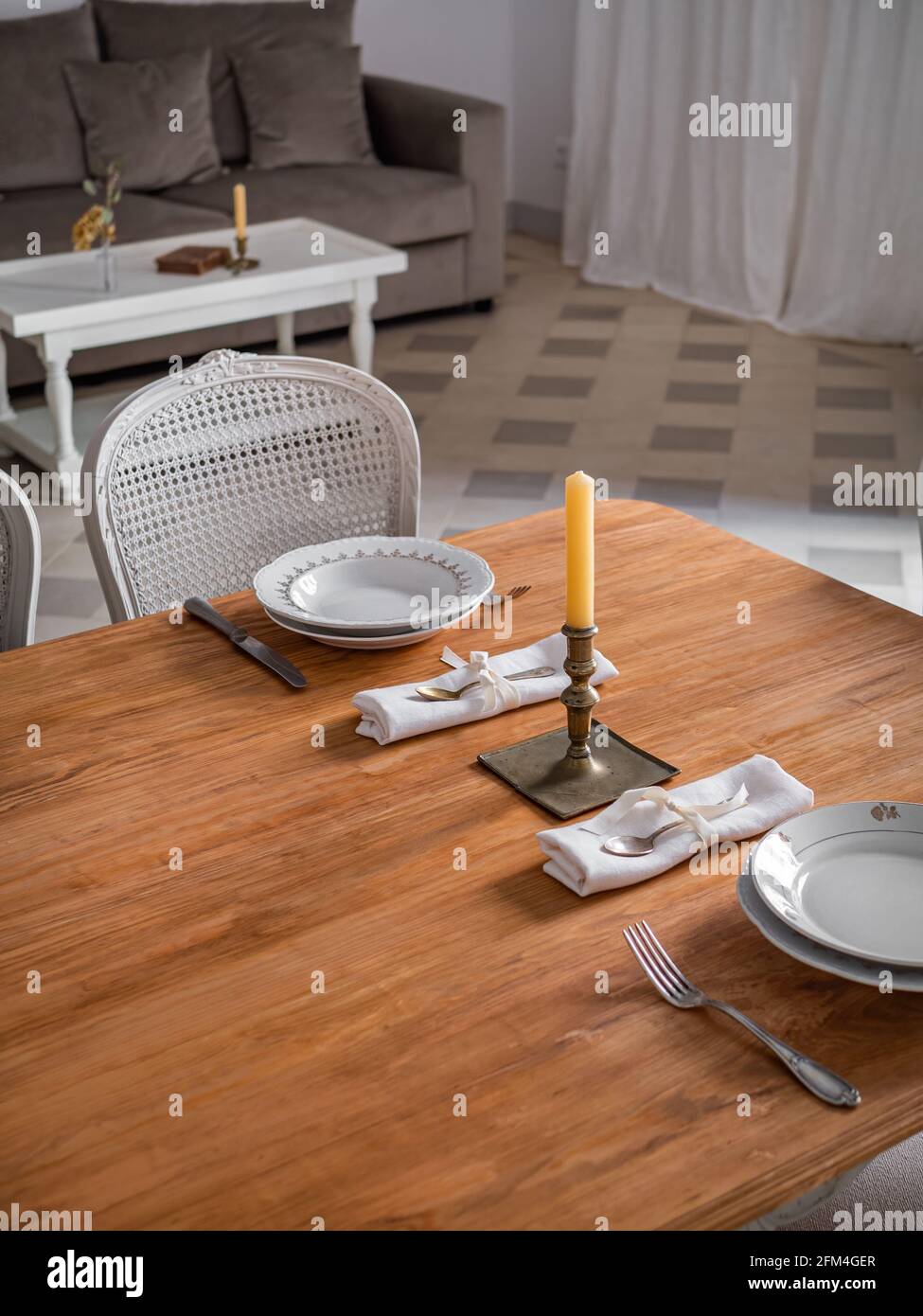 Wooden table setting for two persons, with plates, cutlery and old ...