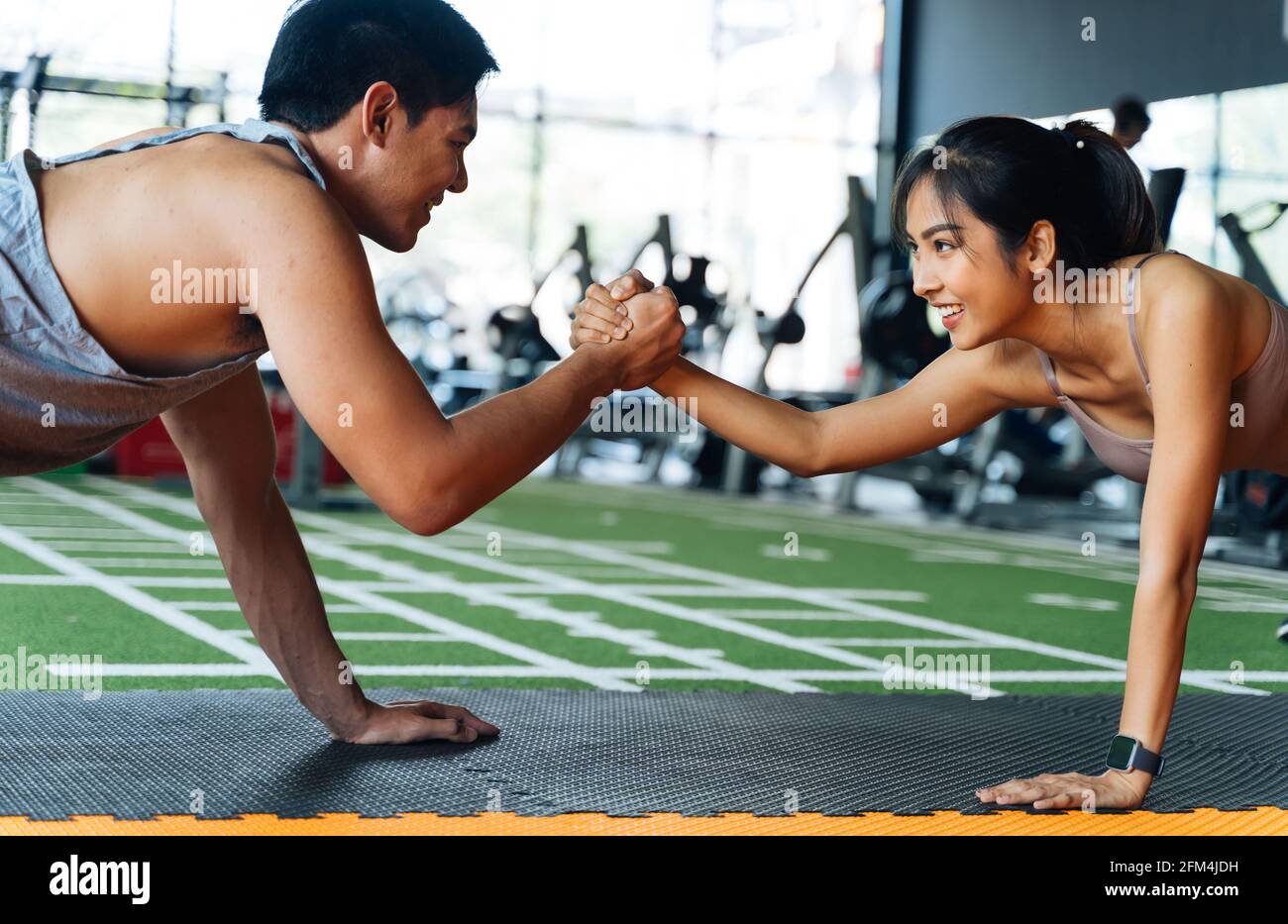 Healthy smiling couple of man and woman giving high five to each other ...