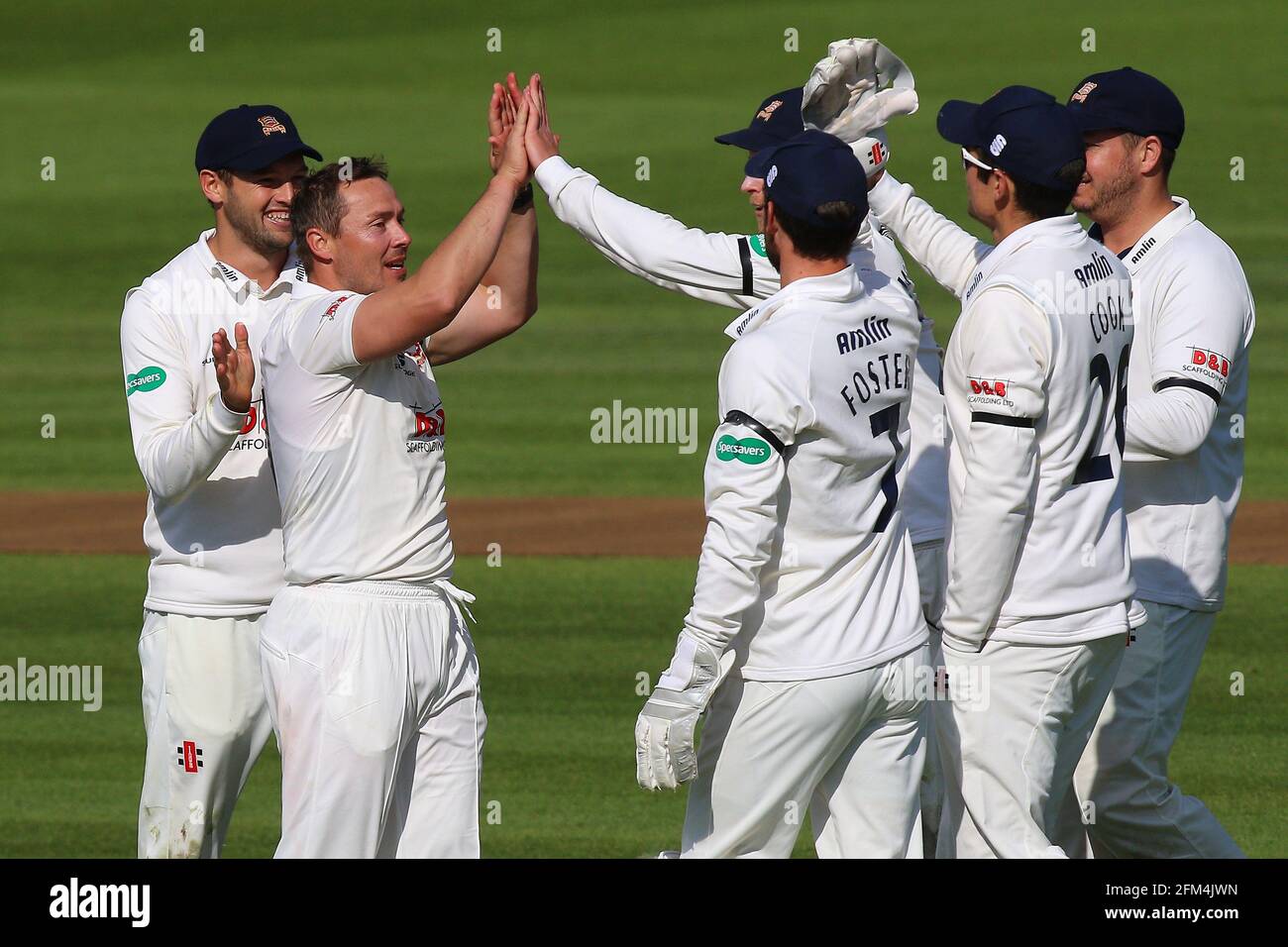 Graham Napier (2nd L) of Essex celebrates taking the wicket of Ben ...