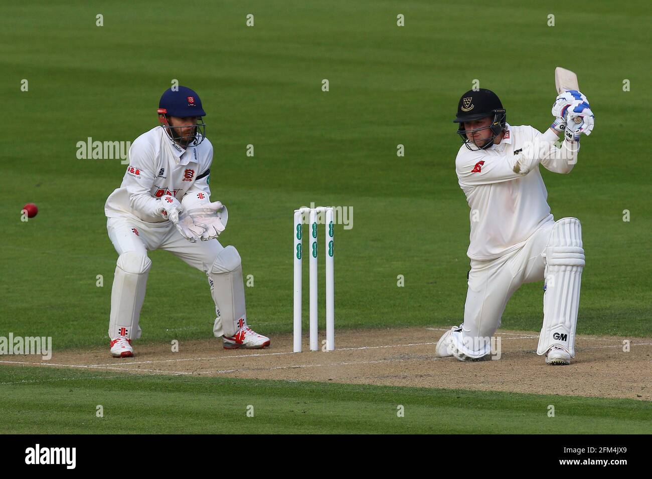 Oliver Robinson in batting action for Sussex as James Foster looks on ...