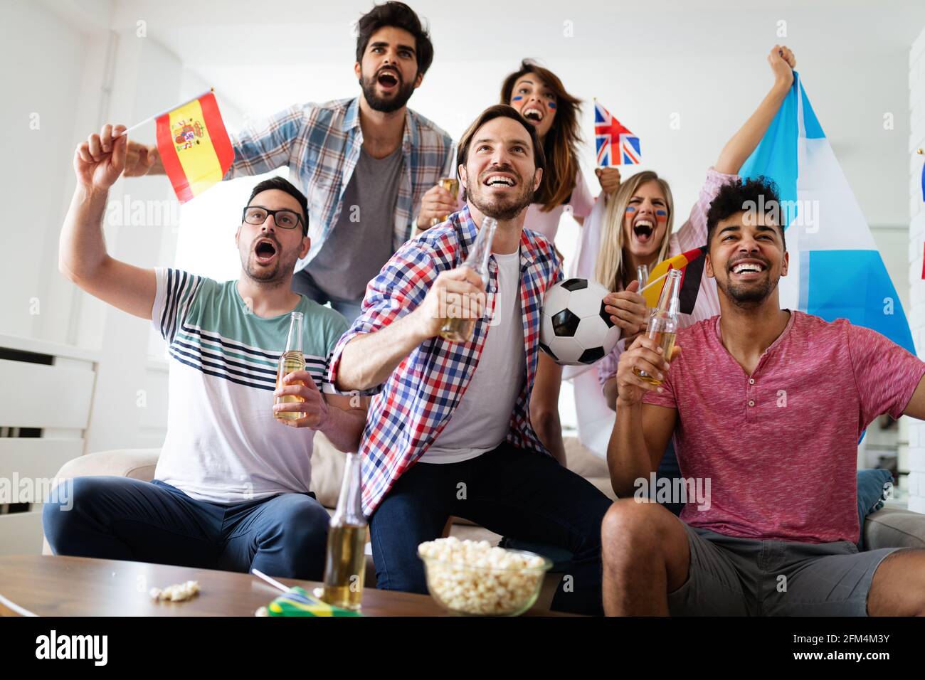 Excited fans of soccer friends celebrating winning match Stock Photo ...