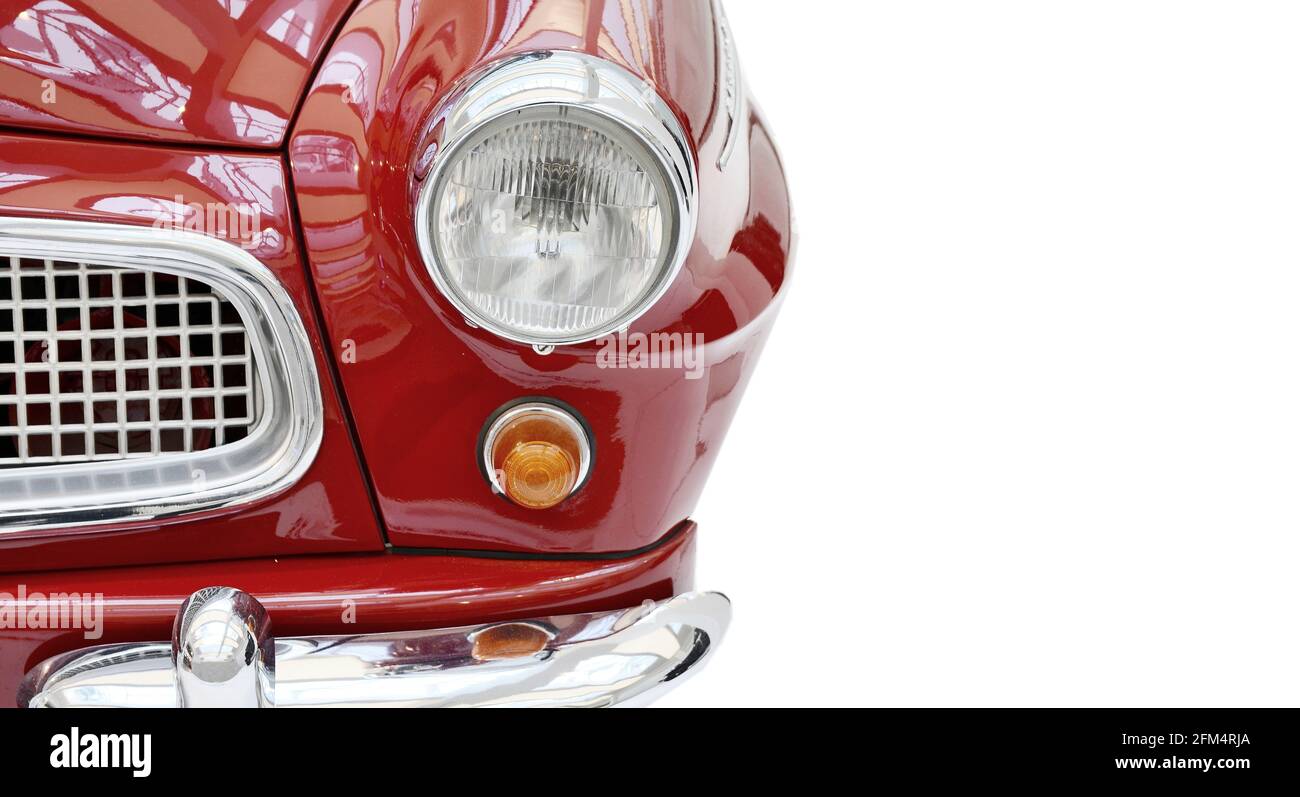 A front view of a red shiny vintage car, isolated on a white background ...