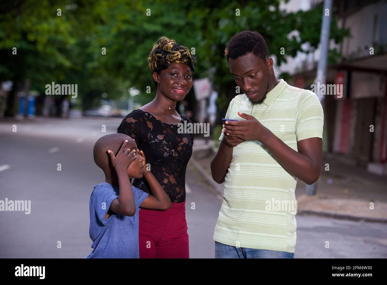 Happy modern family, father, mother and son visiting city together ...