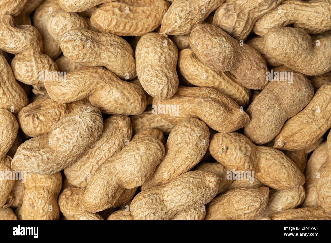 Peanuts in nutshell as a background Stock Photo - Alamy