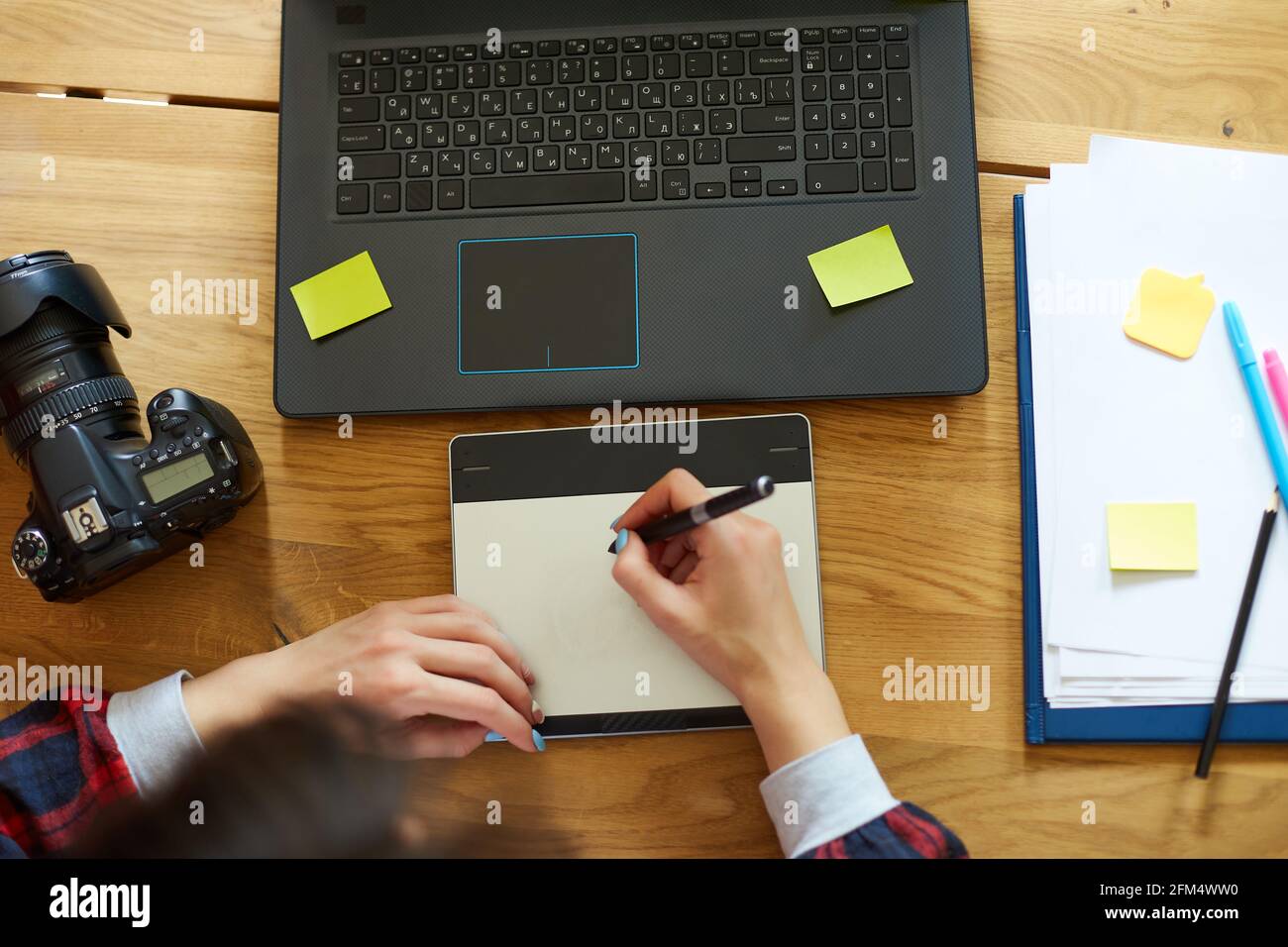 Creative female photographer, using graphic drawing tablet and stylus ...