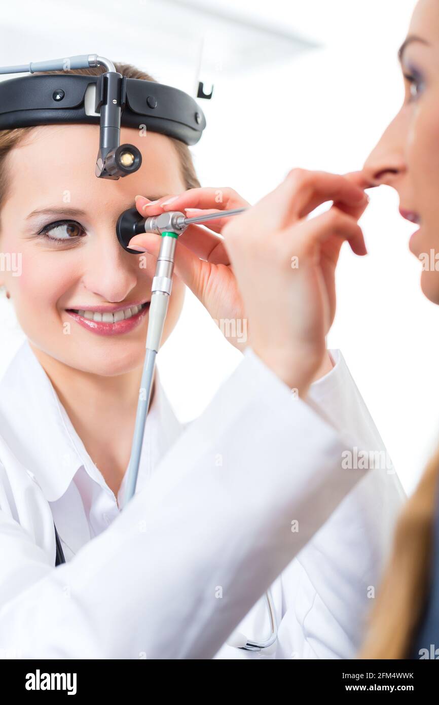 Doctor - Young female consultant or ENT specialist - with a patient in ...