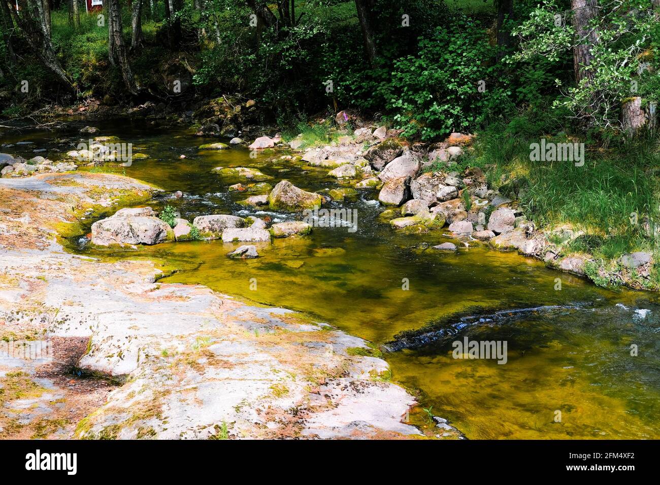Finland, Kotka: Langinkoski rapid on the Kumi river. Faast forest creek ...