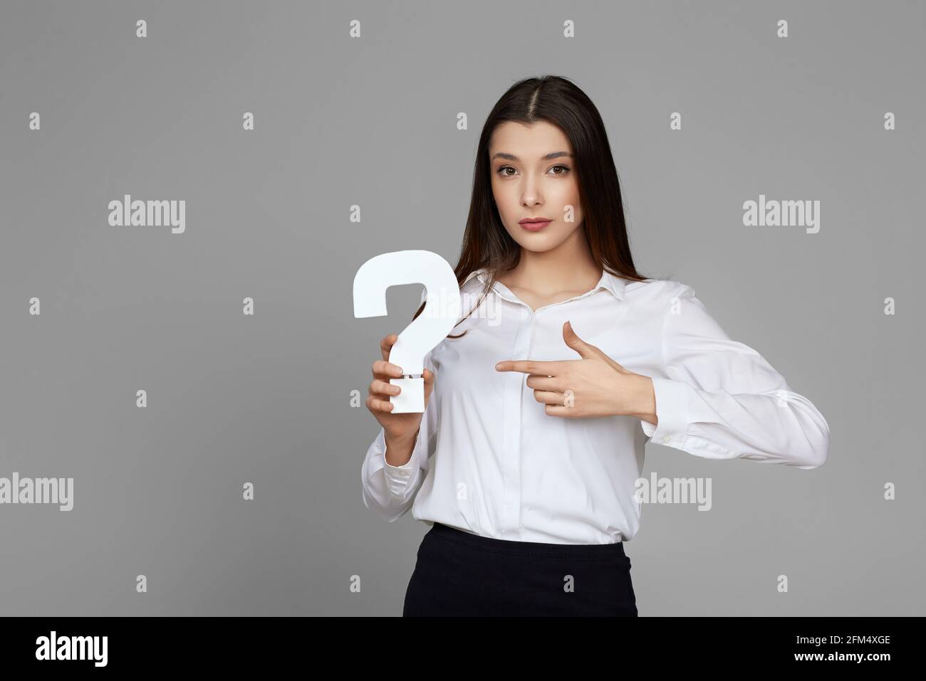 beautiful caucasian business woman with question mark Stock Photo - Alamy