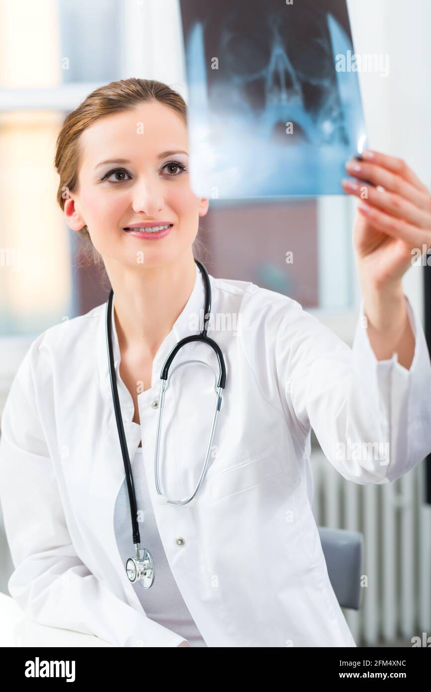 Radiology - female Doctor looking at a tomography x-ray picture of a ...