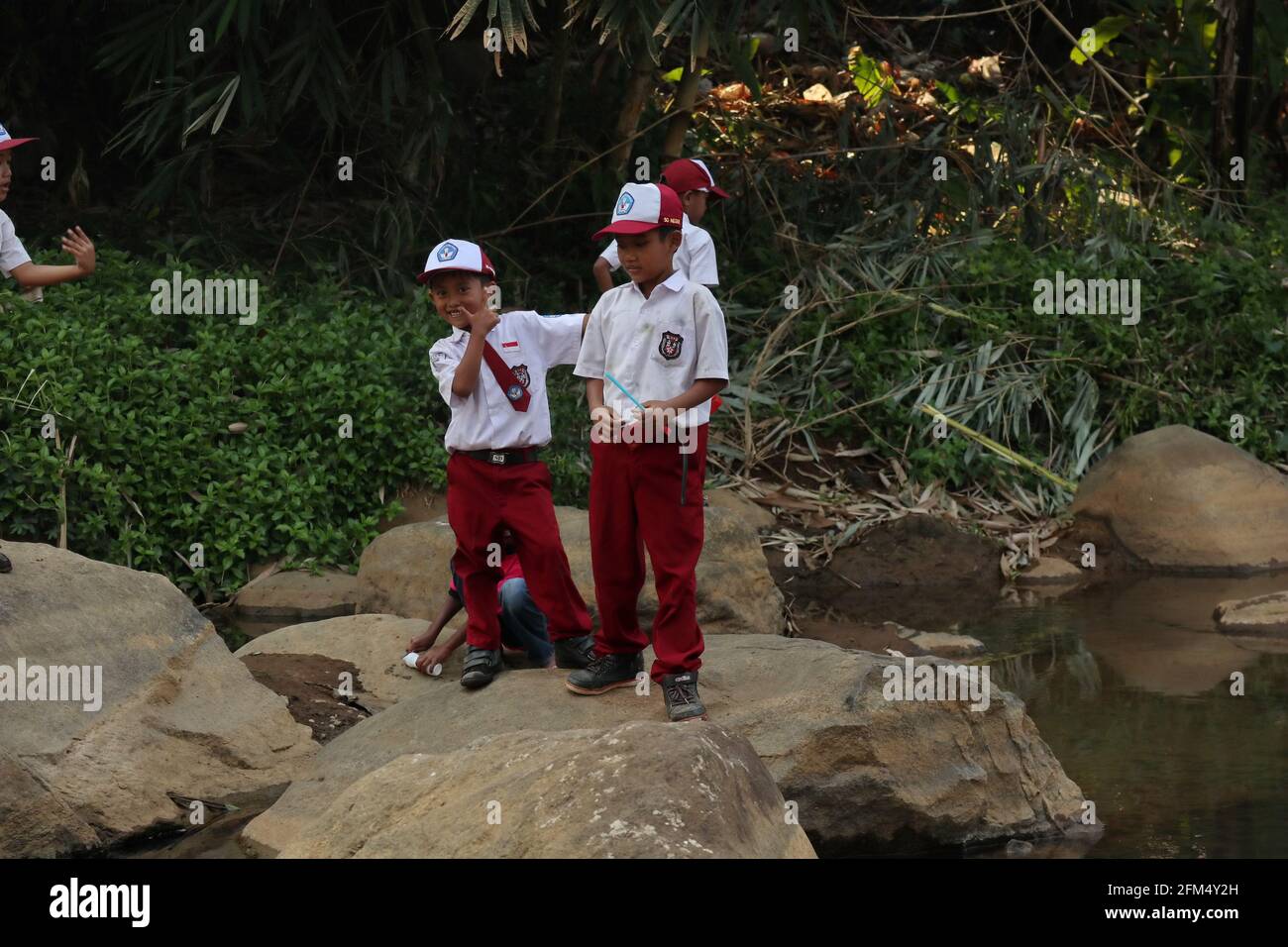 Group of elementary school students playing by the river Stock Photo ...