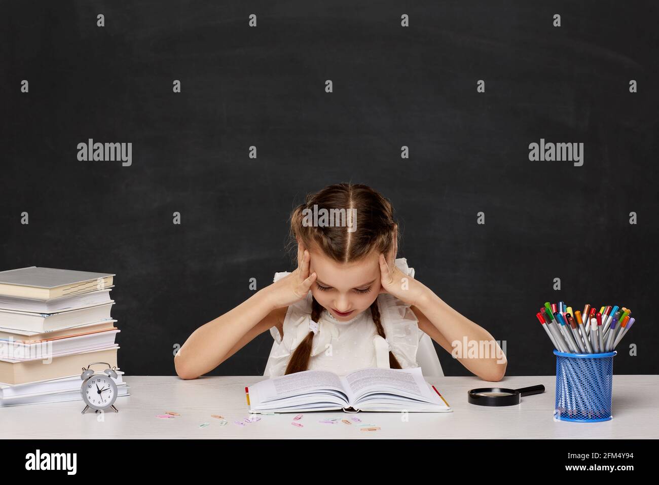 Sad girl sitting in classroom hi-res stock photography and images - Alamy