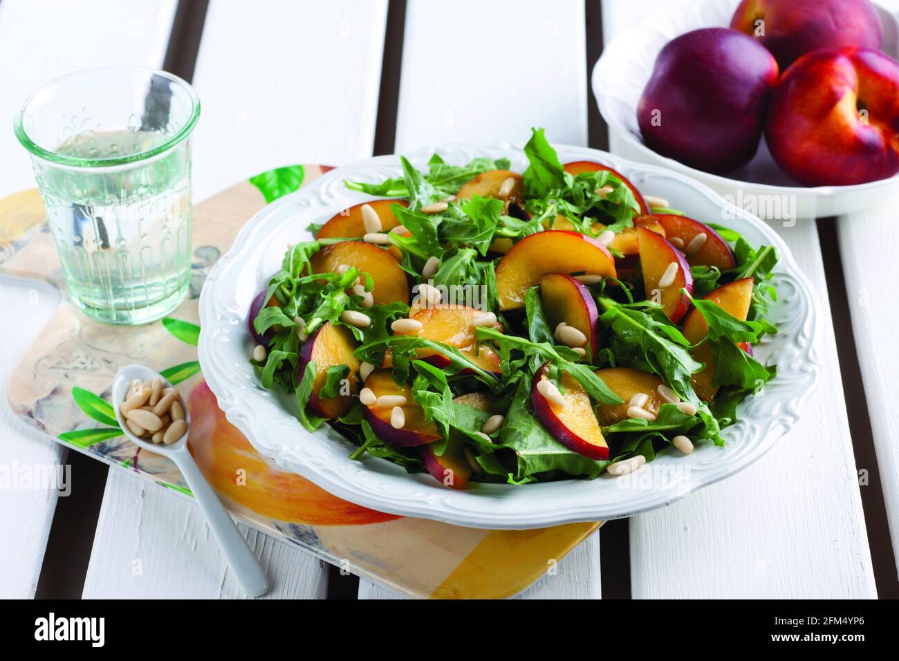 Salad with nectarines dandelion rocket salad and pine nuts Stock Photo ...