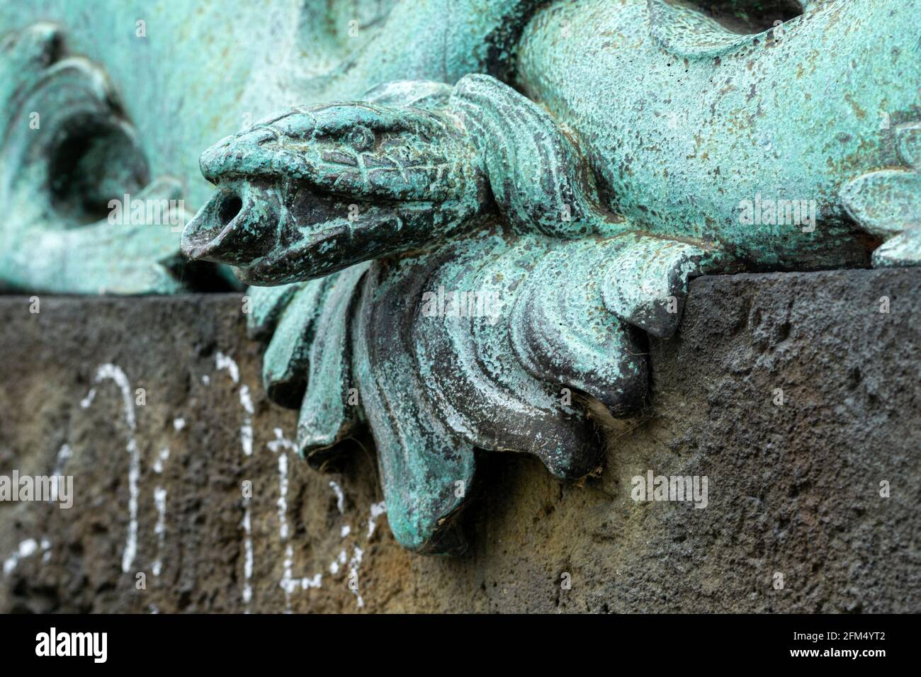 Blue granite sculpture of a snake with a hole Stock Photo - Alamy