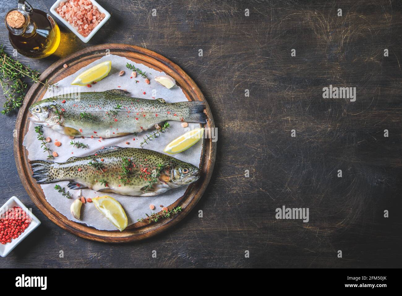 two raw rainbow trouts on paper with thyme and lemon. Fish trout. Top ...