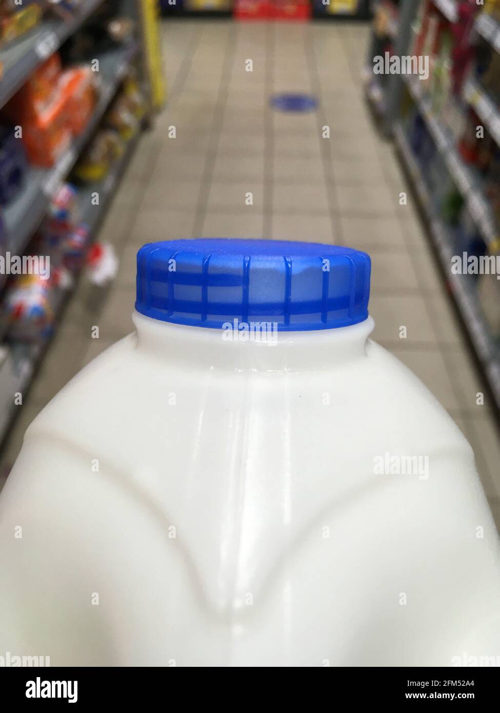 A carton of British full fat pasteurised milk with a blue bottle top ...