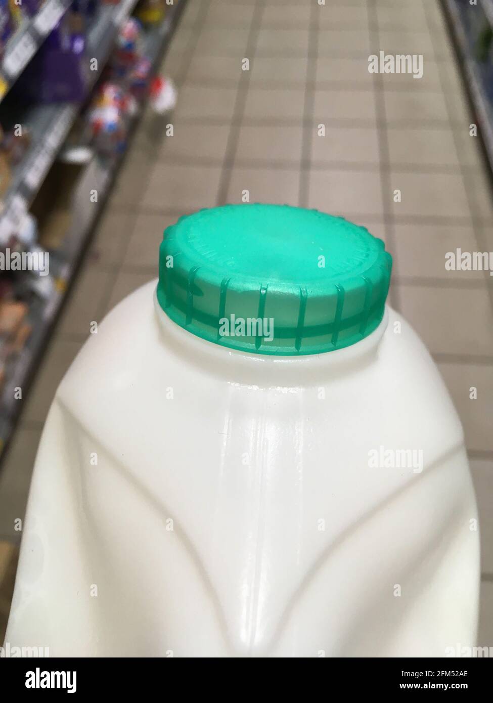 A carton of British semi skimmed pasteurised milk with a green bottle ...
