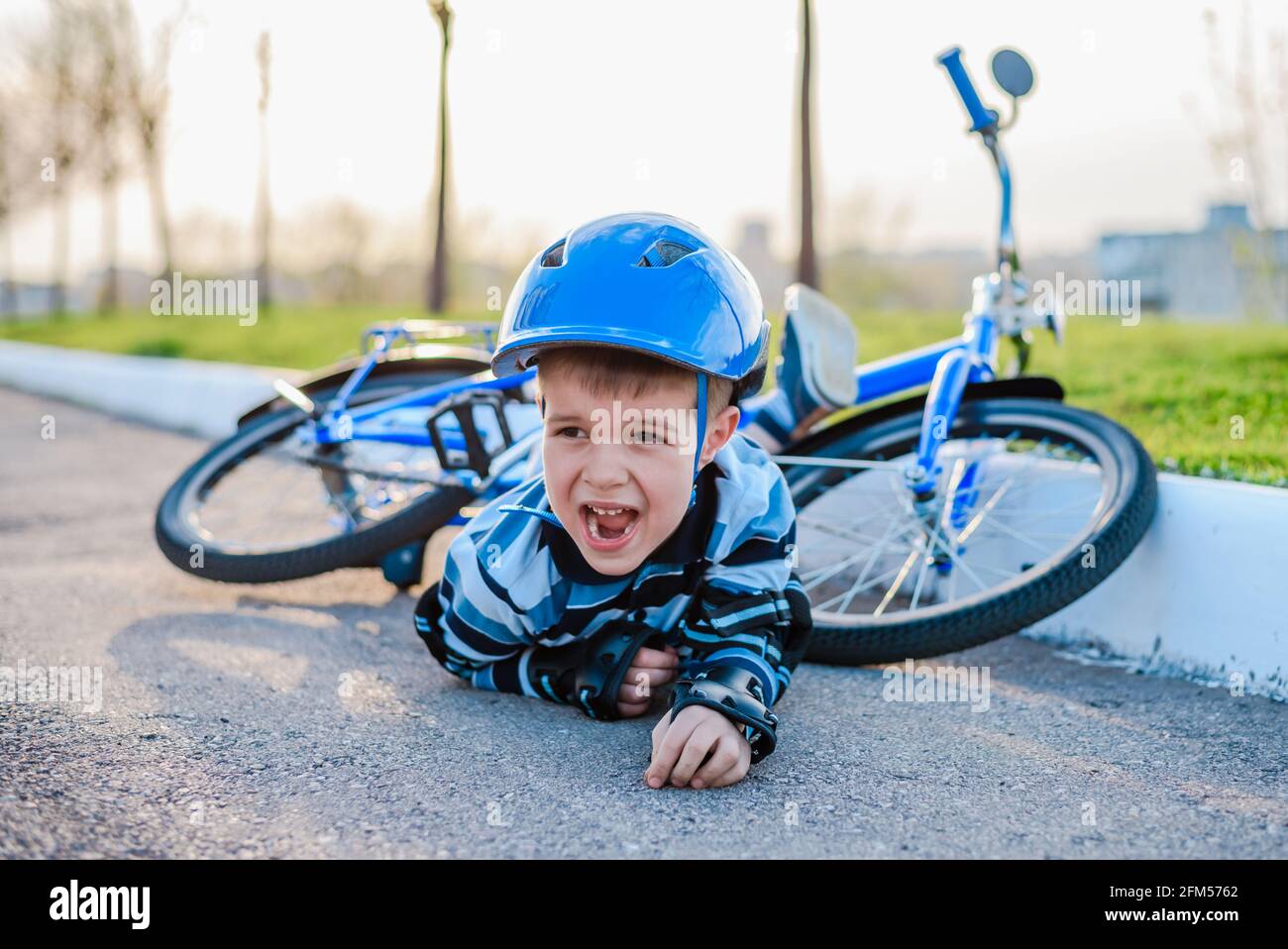 A small child fell from a bicycle crying and screaming in pain Stock ...