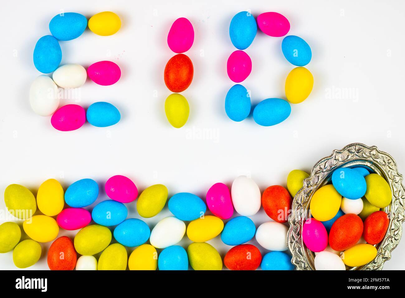 Eid text written with candies on white background. Eid al fitr, ramadan ...