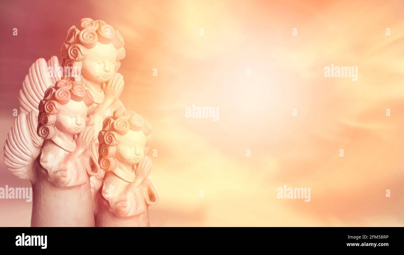 Three angels praying, religious background with space for text. Golden ...