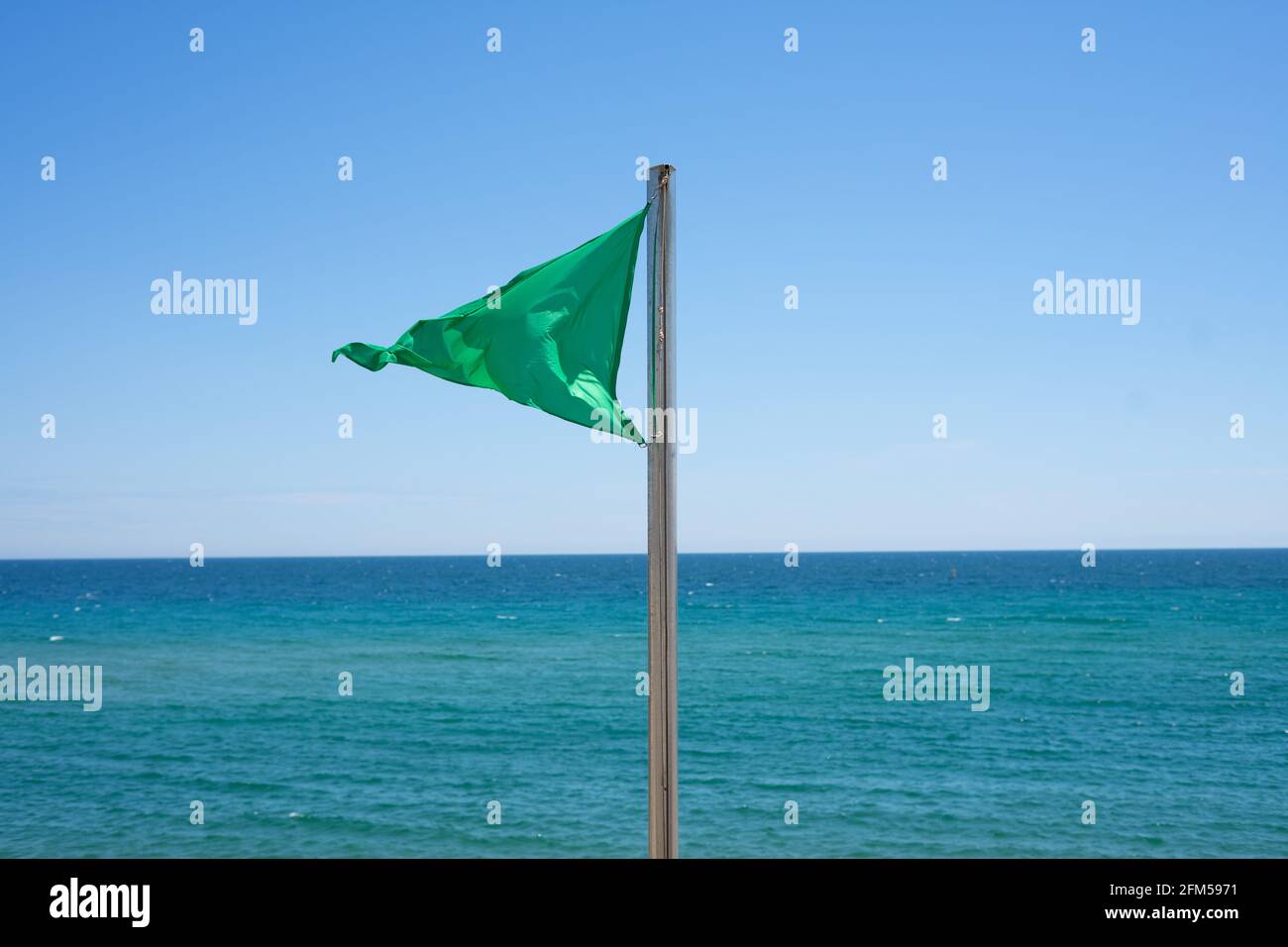 Green flag on beach hi-res stock photography and images - Alamy