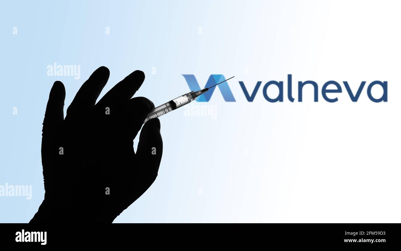 In this photo illustration a hand holding a medical syringe is seen ...