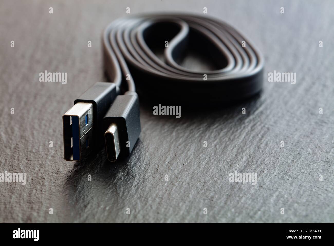 Black USB Type-C cord on black background for design purpose Stock ...