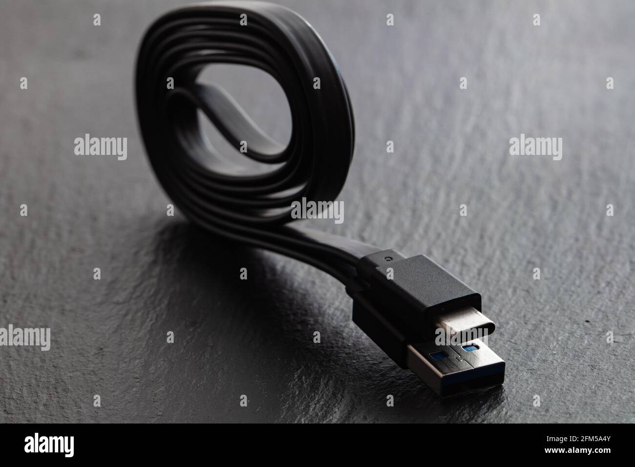 Black USB Type-C cord on black background for design purpose Stock ...