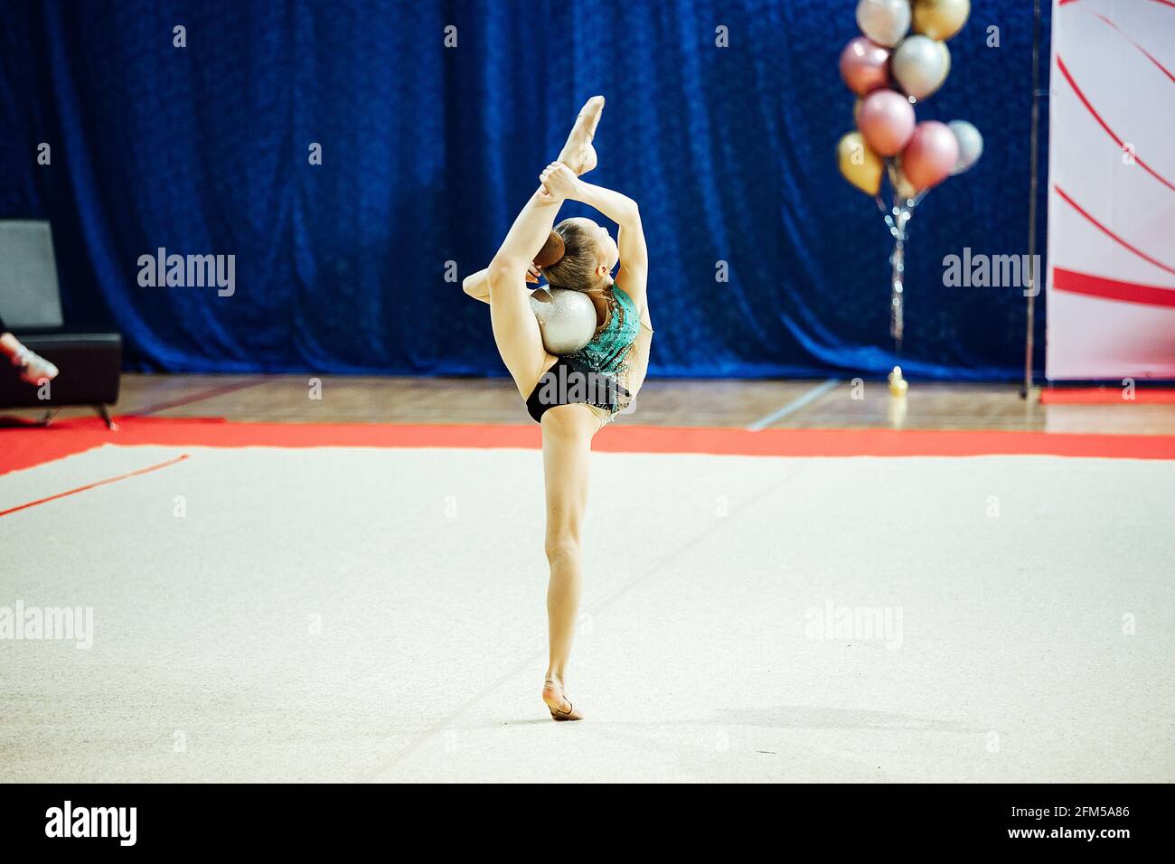 a gymnast girl performs with a hoop. flexible athlete performs a ... a gymnast girl performs with a hoop. flexible athlete performs a ...