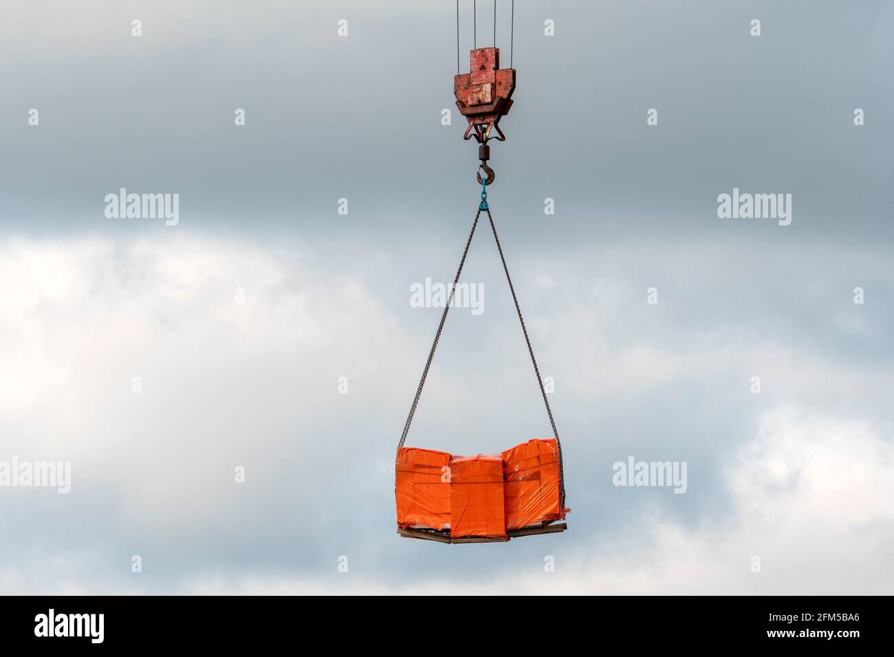 Unloading of building materials by crane at the construction site Stock ...