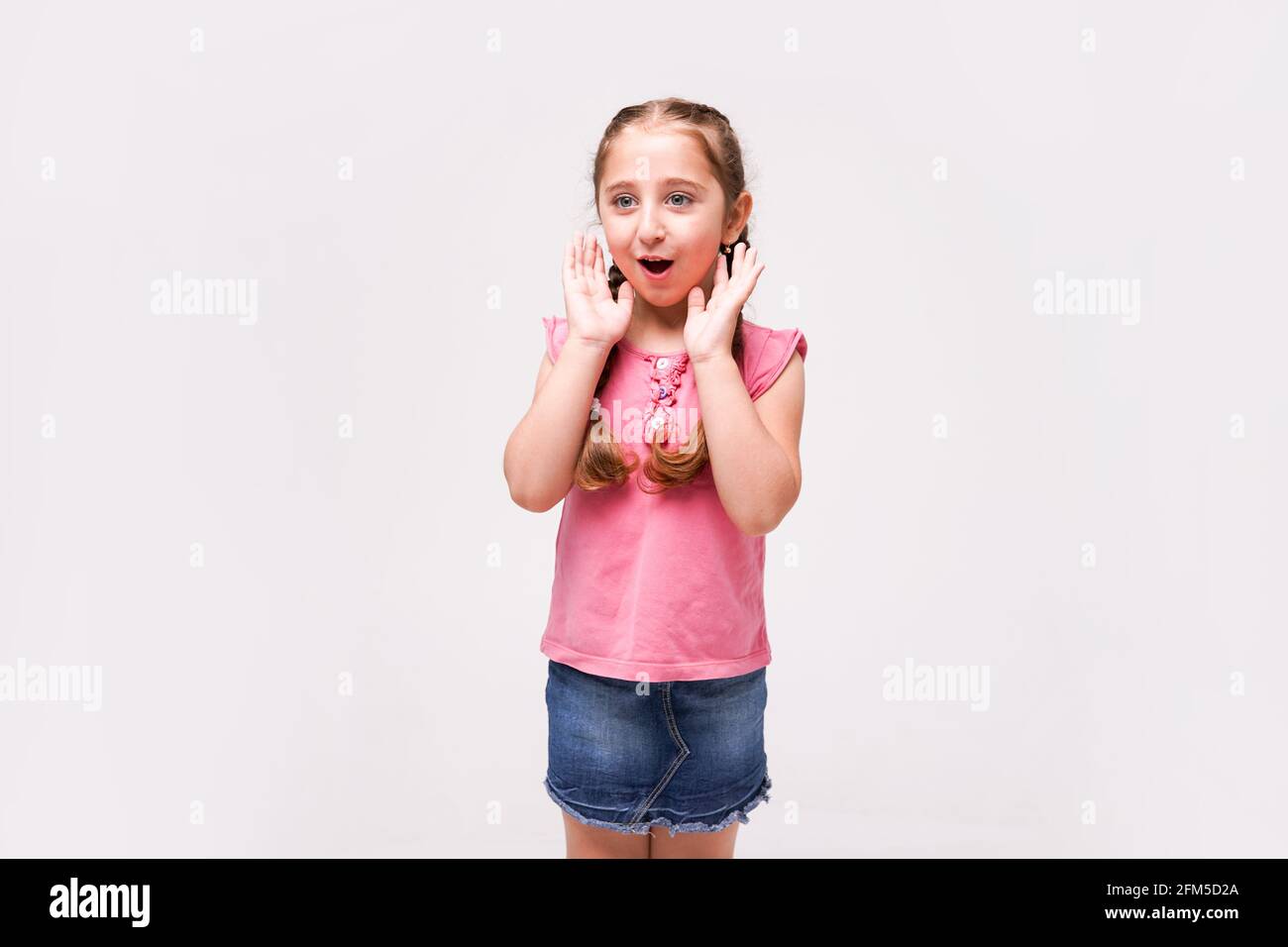 Surprised smiling little girl isolated on white background Stock Photo ...