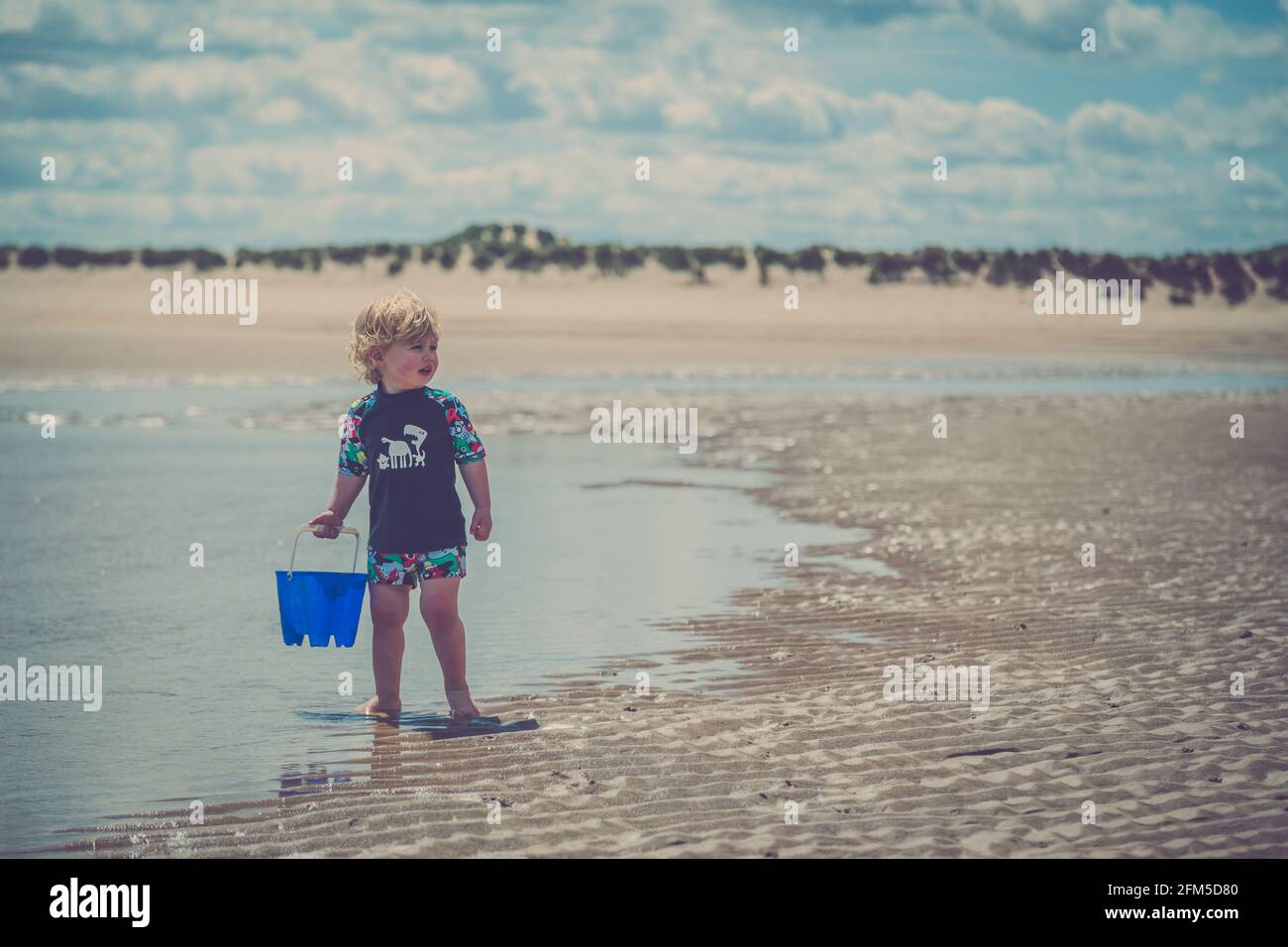 Young Boy playing on beach Stock Photo - Alamy