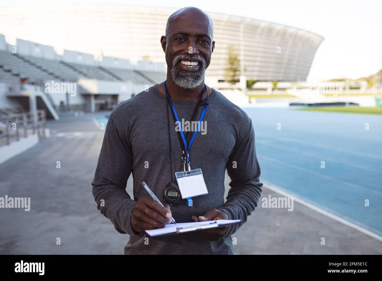 Happy coach standing hi-res stock photography and images - Alamy
