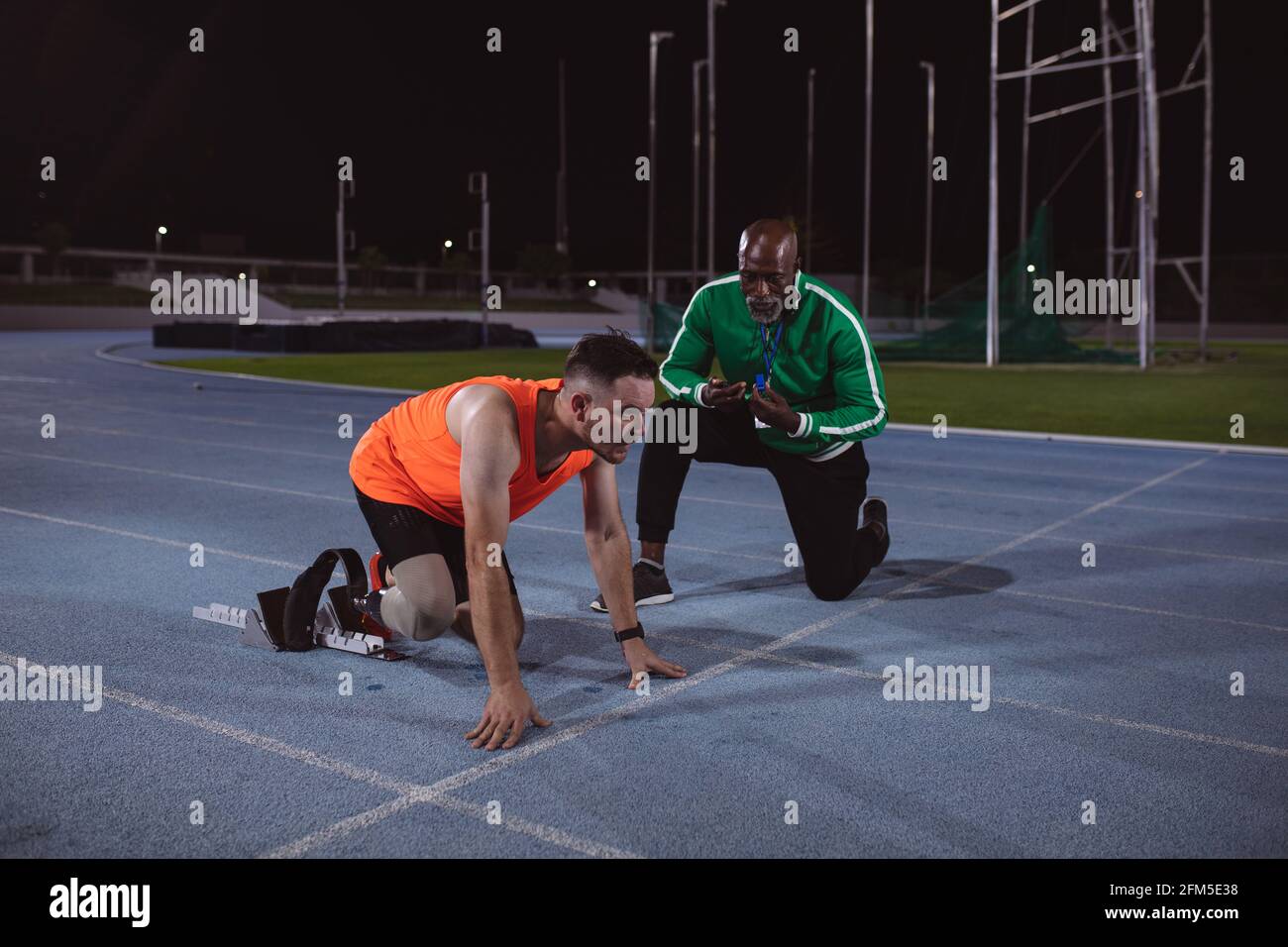 Caucasian male athlete with prosthetic leg in starting position for ...