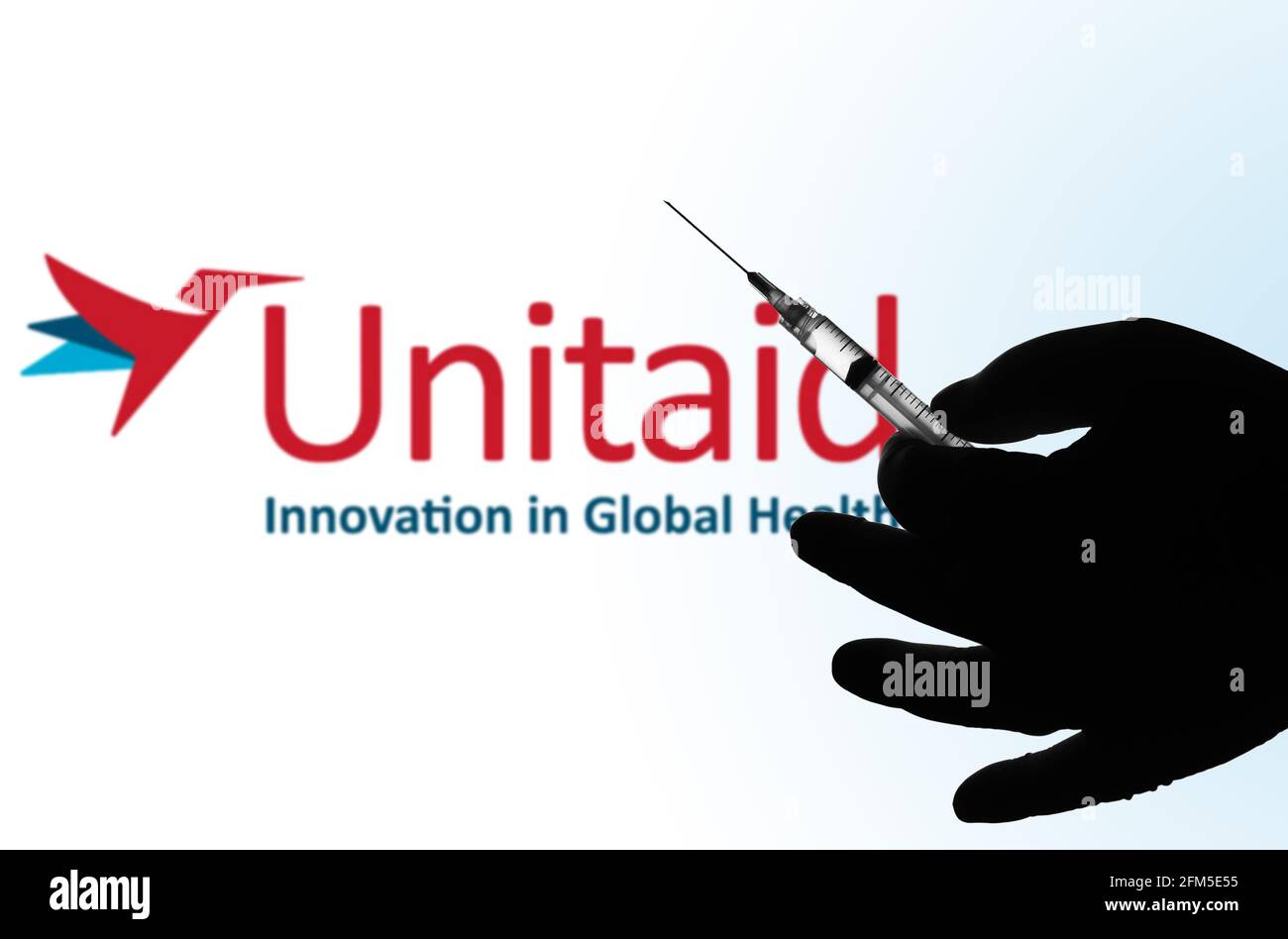 Brazil. 8th Apr, 2021. In this photo illustration a hand holding a medical syringe is seen with ...