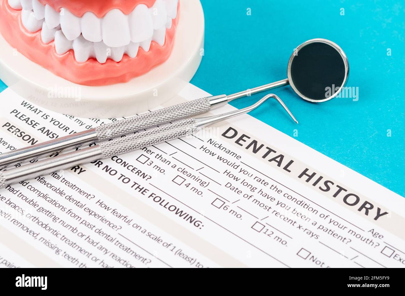 New patient medical form with model tooth and dental instruments ...