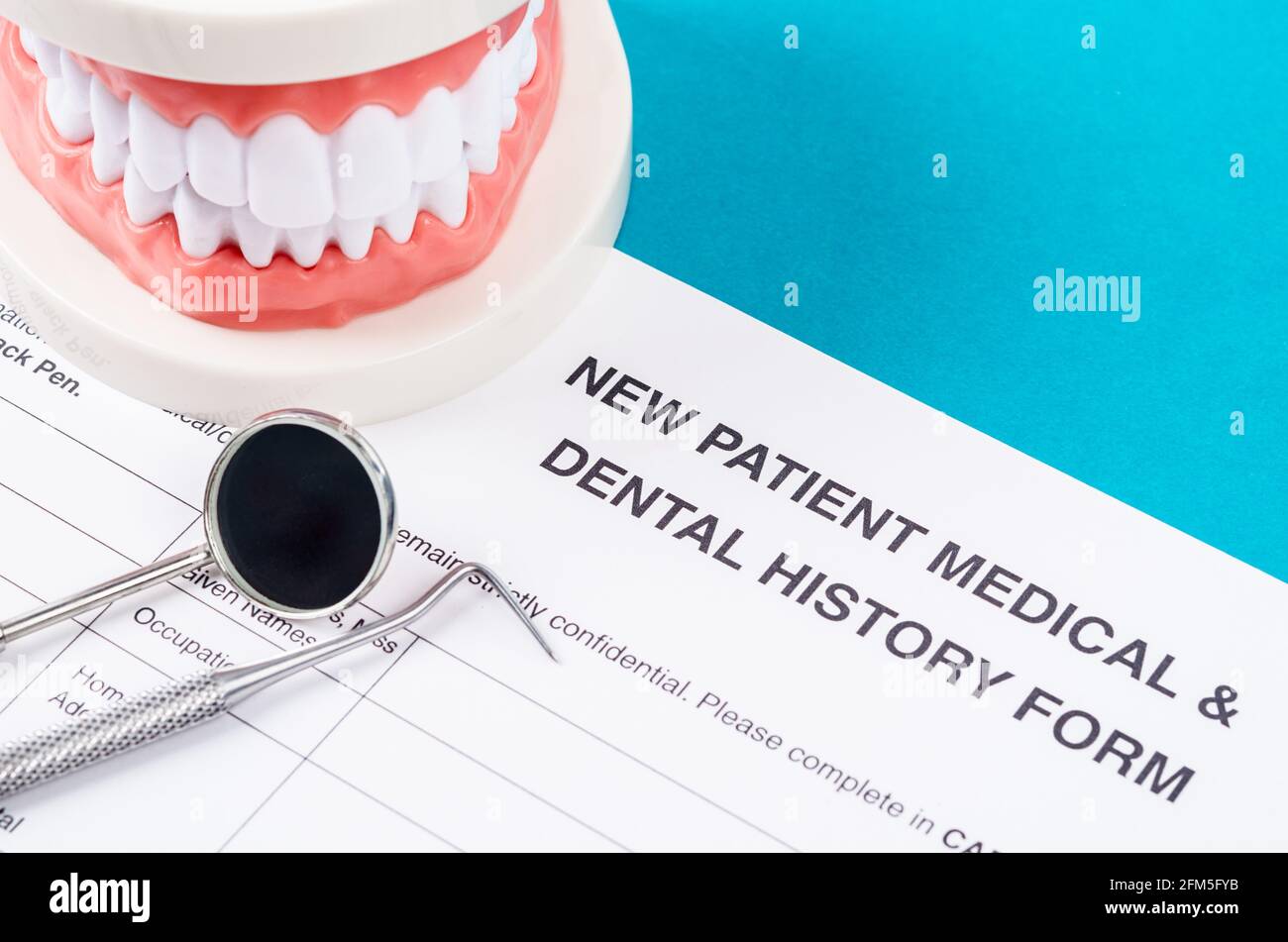 New patient medical form with model tooth and dental instruments ...