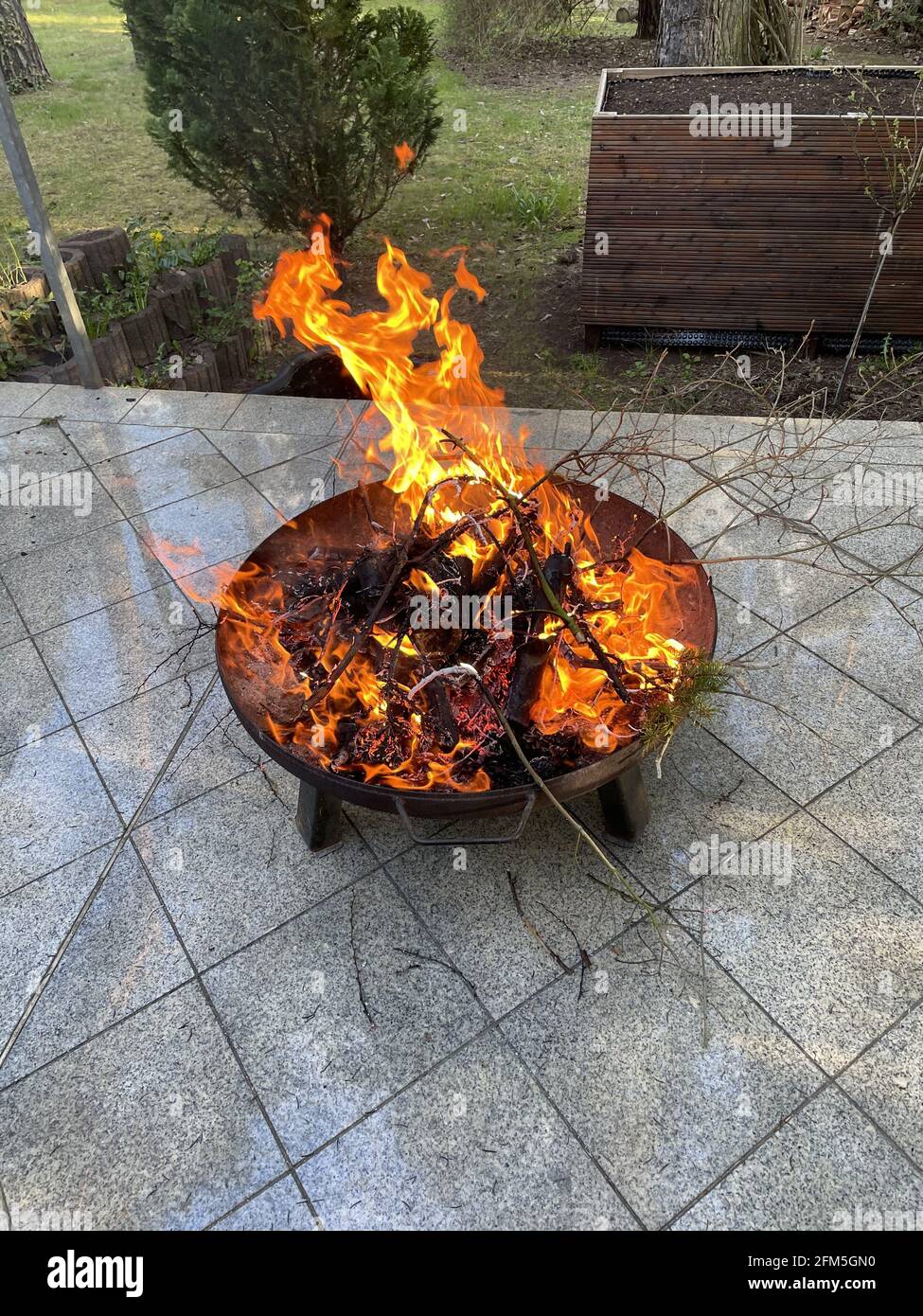 Vertical shot of flaming bonfire on a pot in the backyard Stock Photo ...