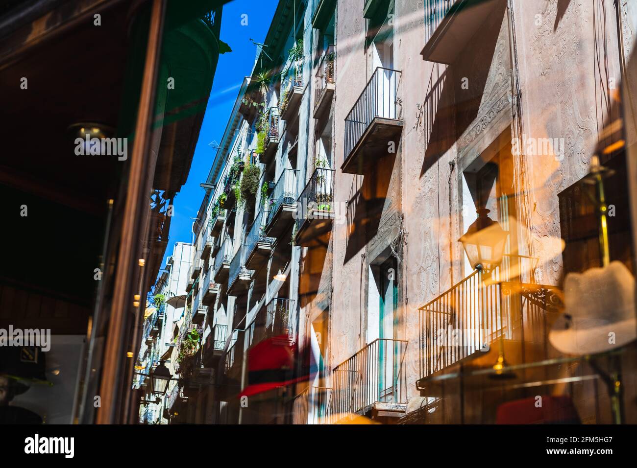 reflection of hats in shop window with facade of buildings Stock Photo ...