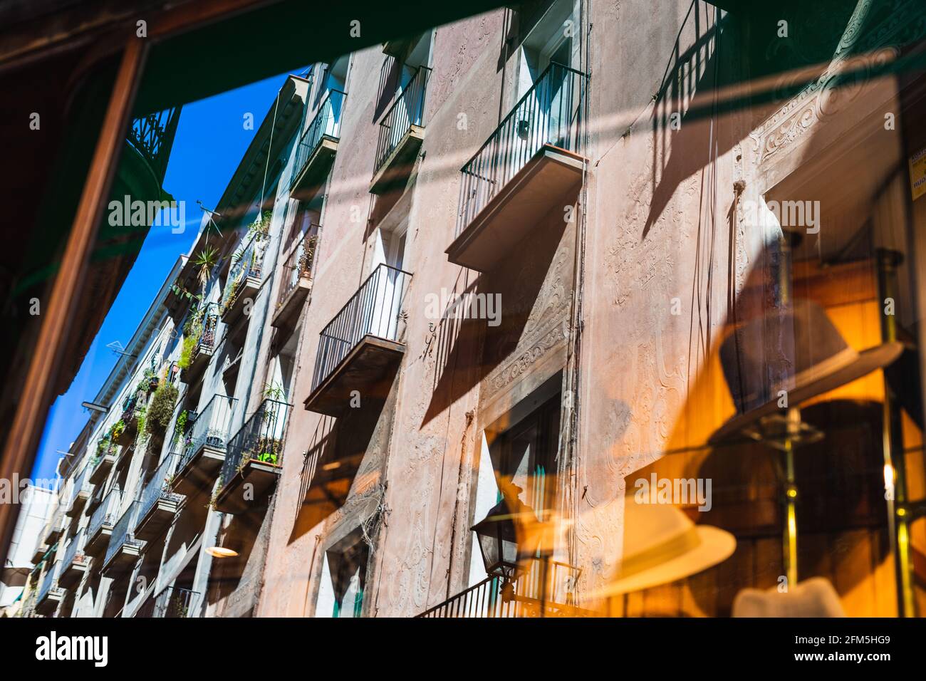 reflection of hats in shop window with facade of buildings Stock Photo ...
